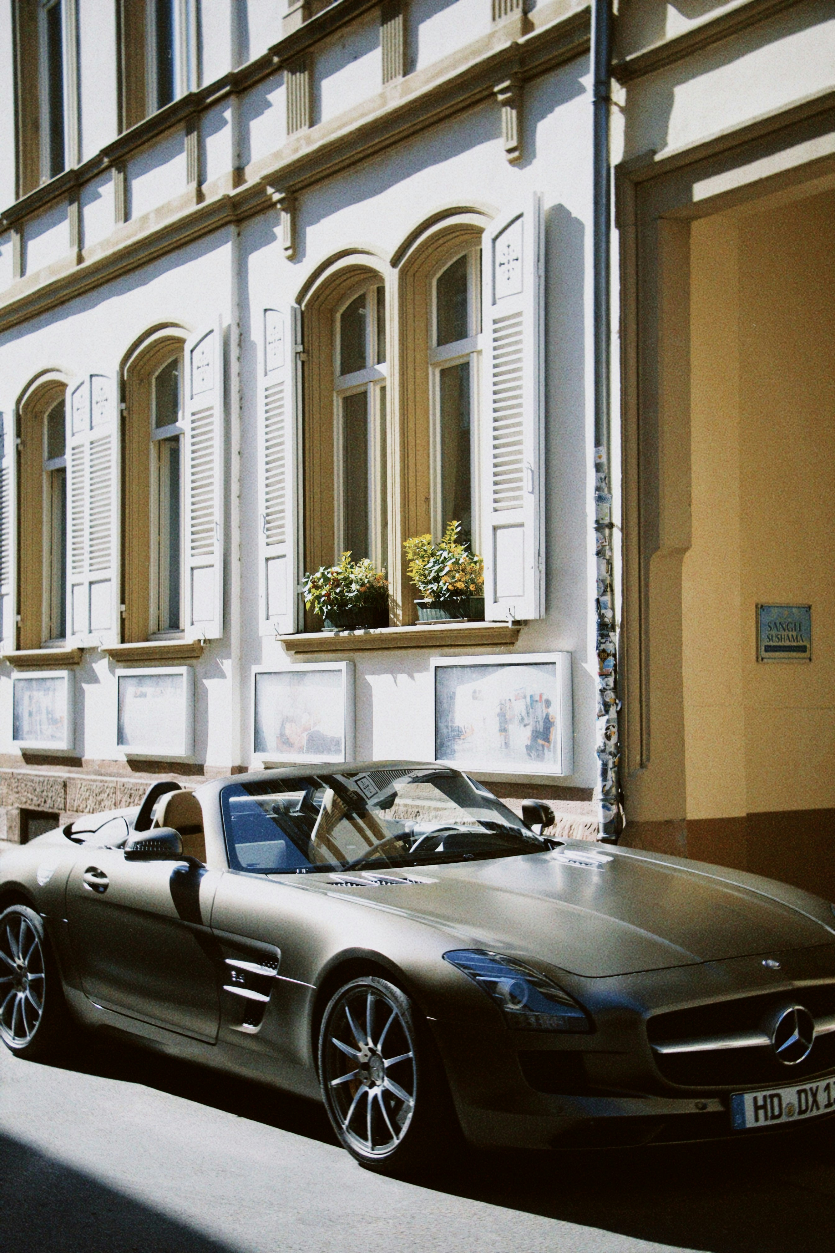Sunlit Mercedes Roadster Framed by a Classic European Façade