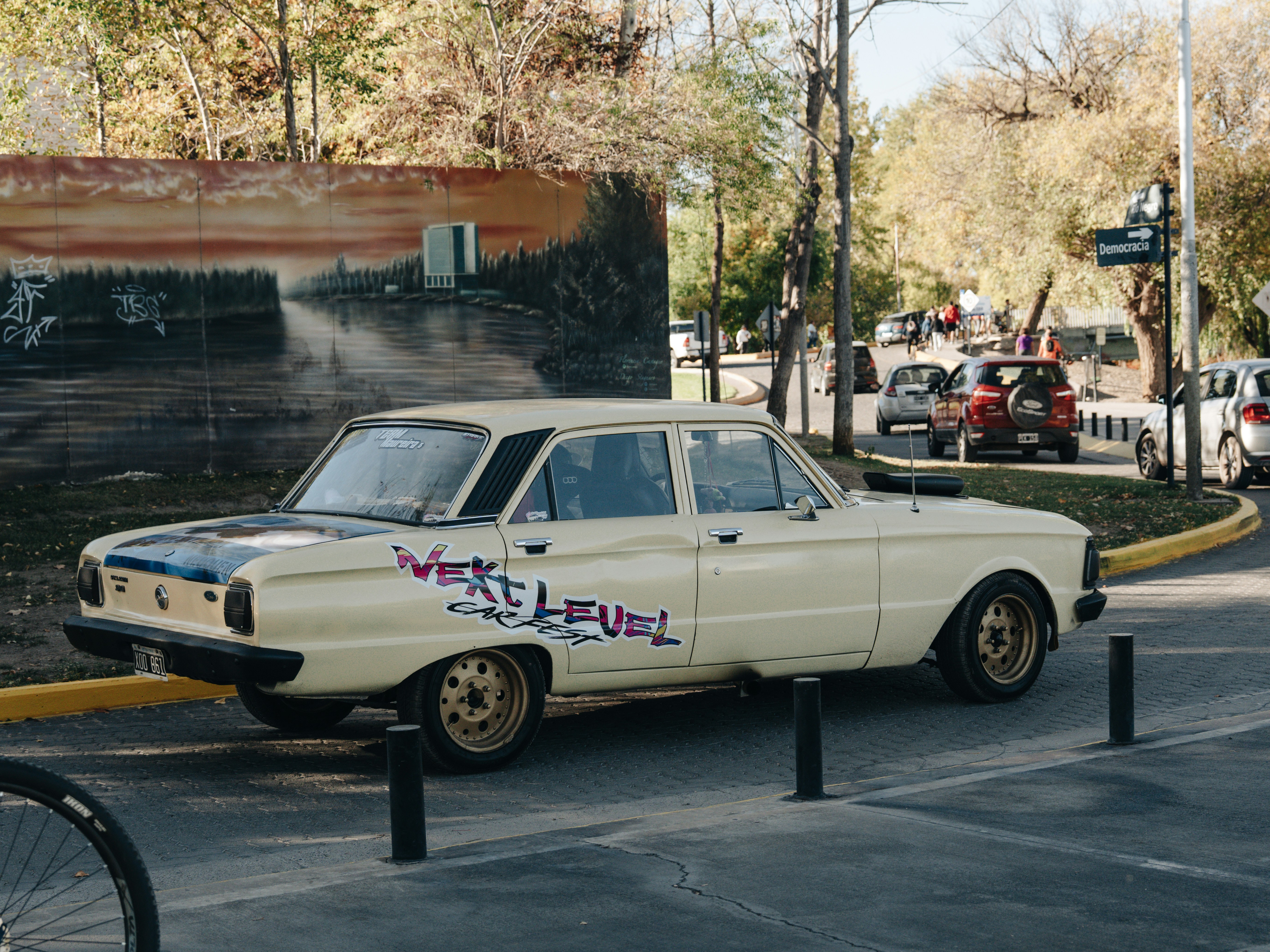 Graffiti-Adorned Cream Classic on a Quiet Autumn Street