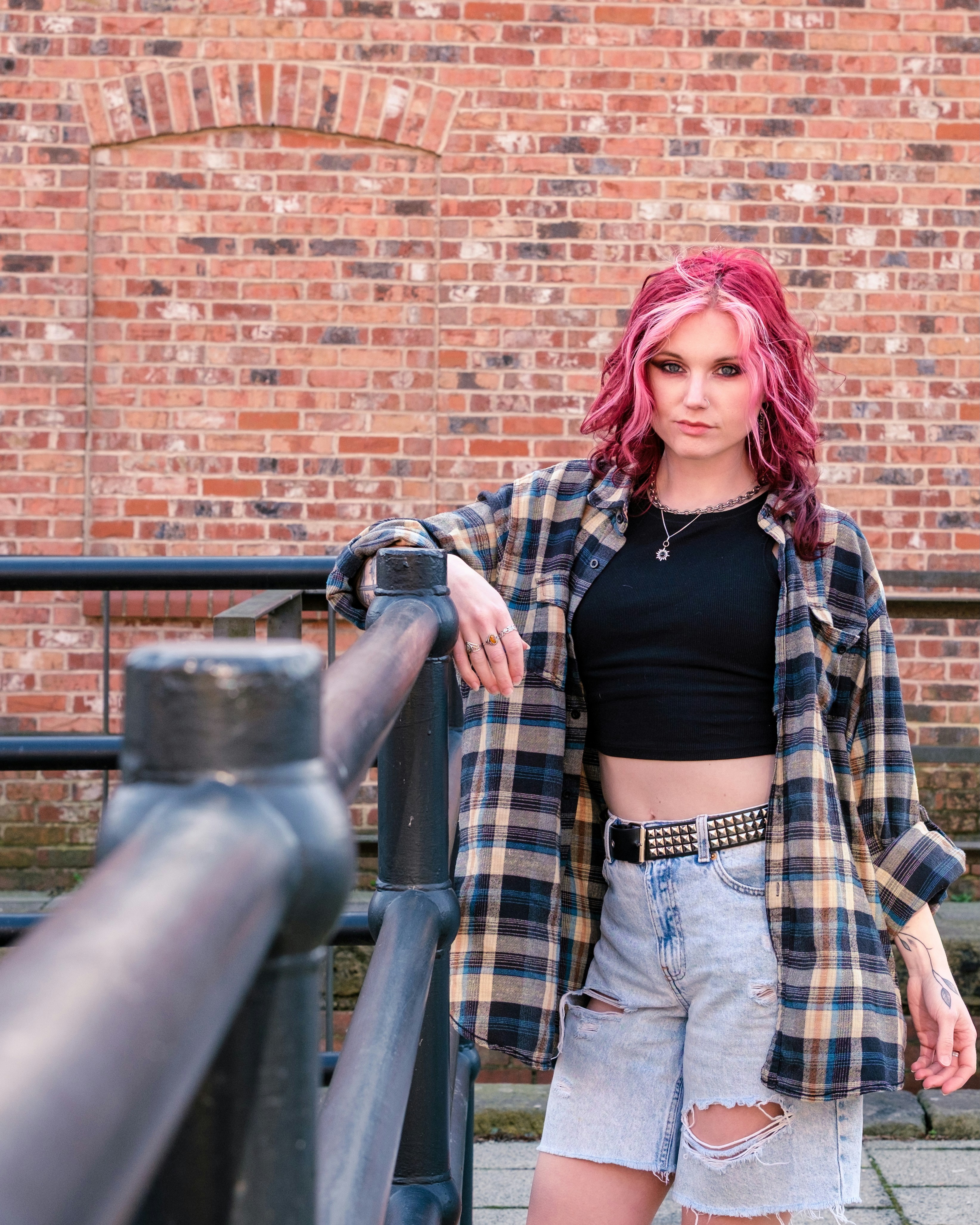 Crimson Hair, Brick Backdrop: A Quiet Portrait of Confidence