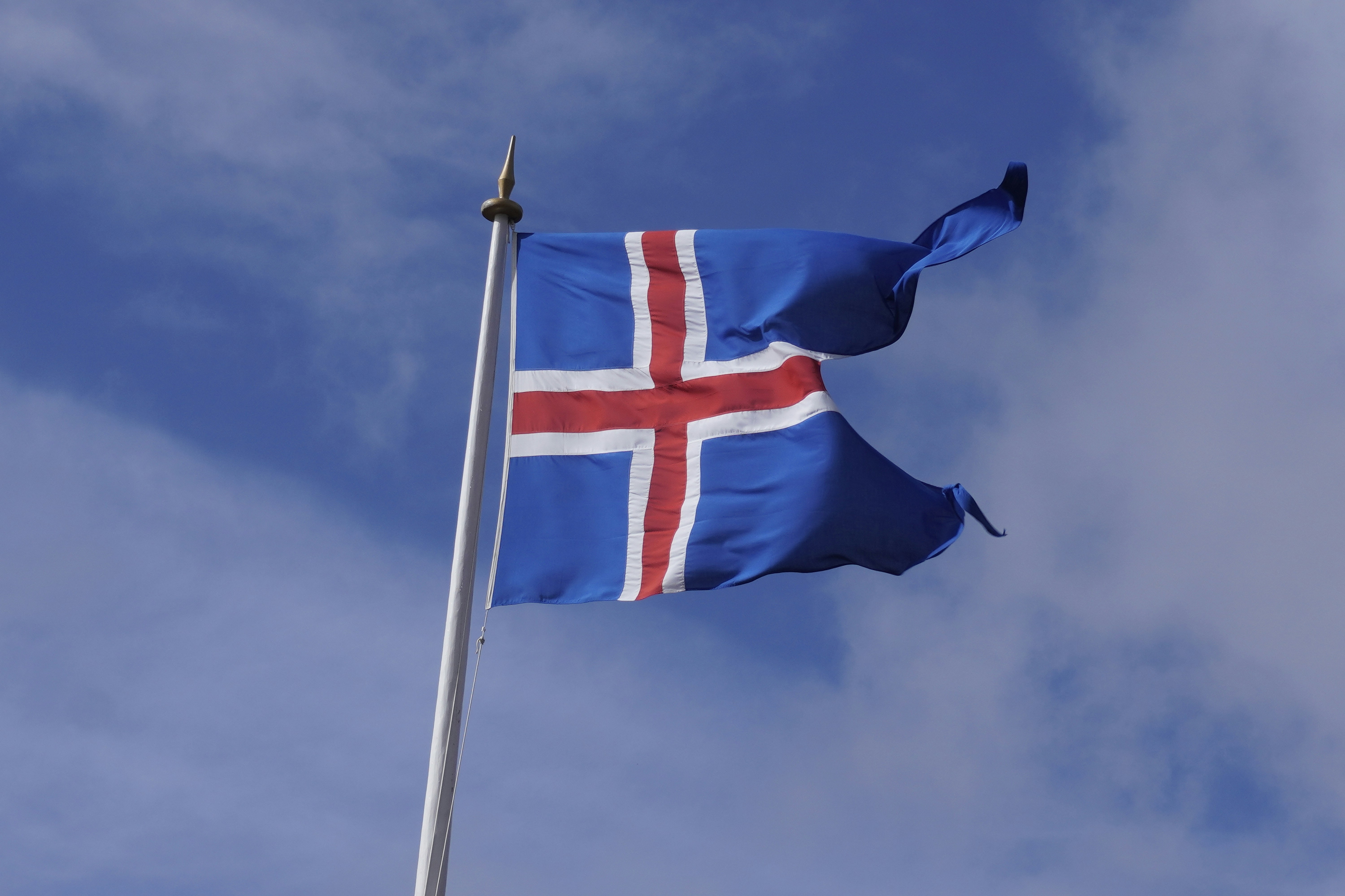Windward Nordic Cross: Flag Ripples Against a Blue Sky