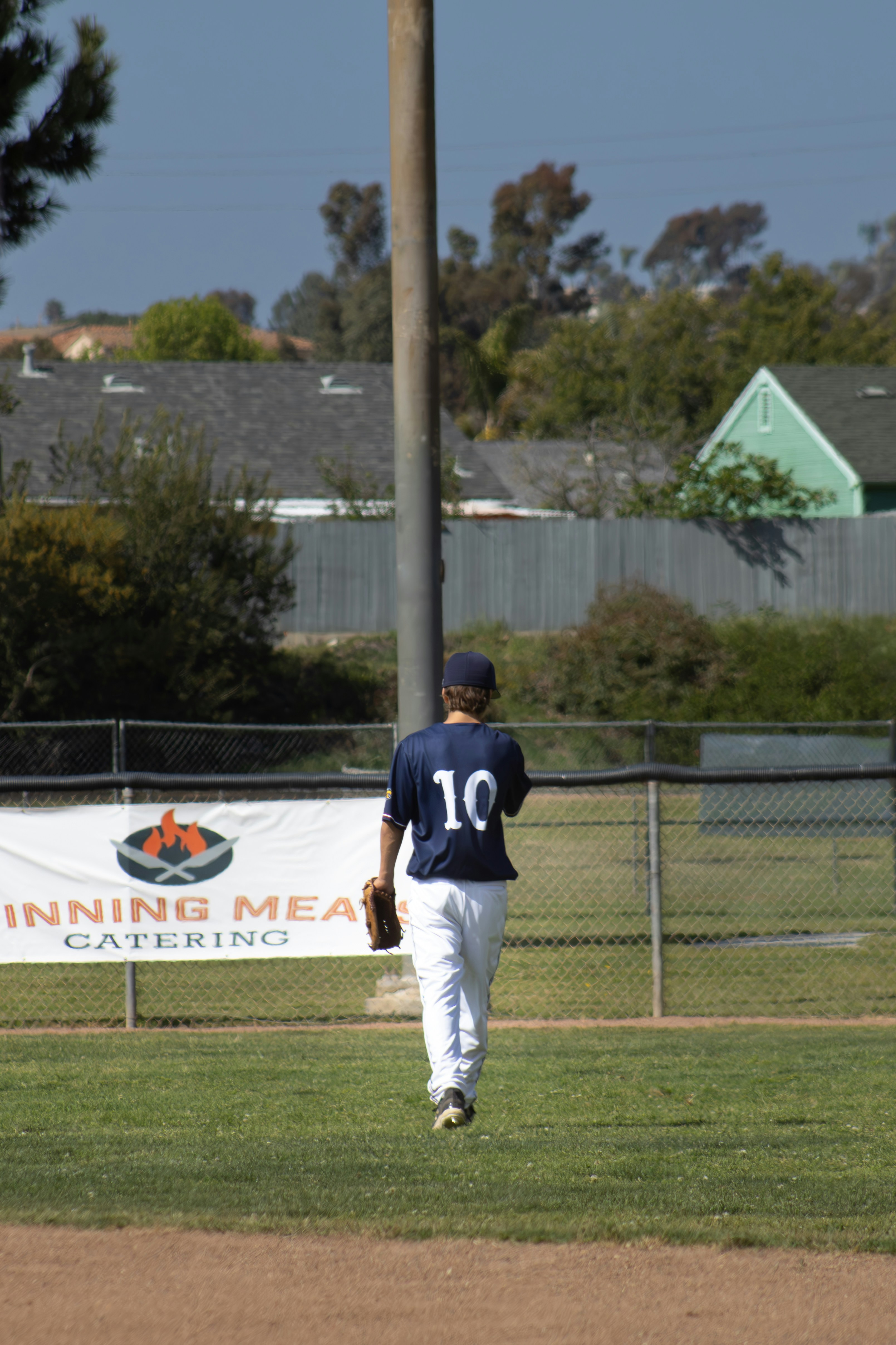 Back-View on the Diamond: The #10 Walks Across a Sunlit Field