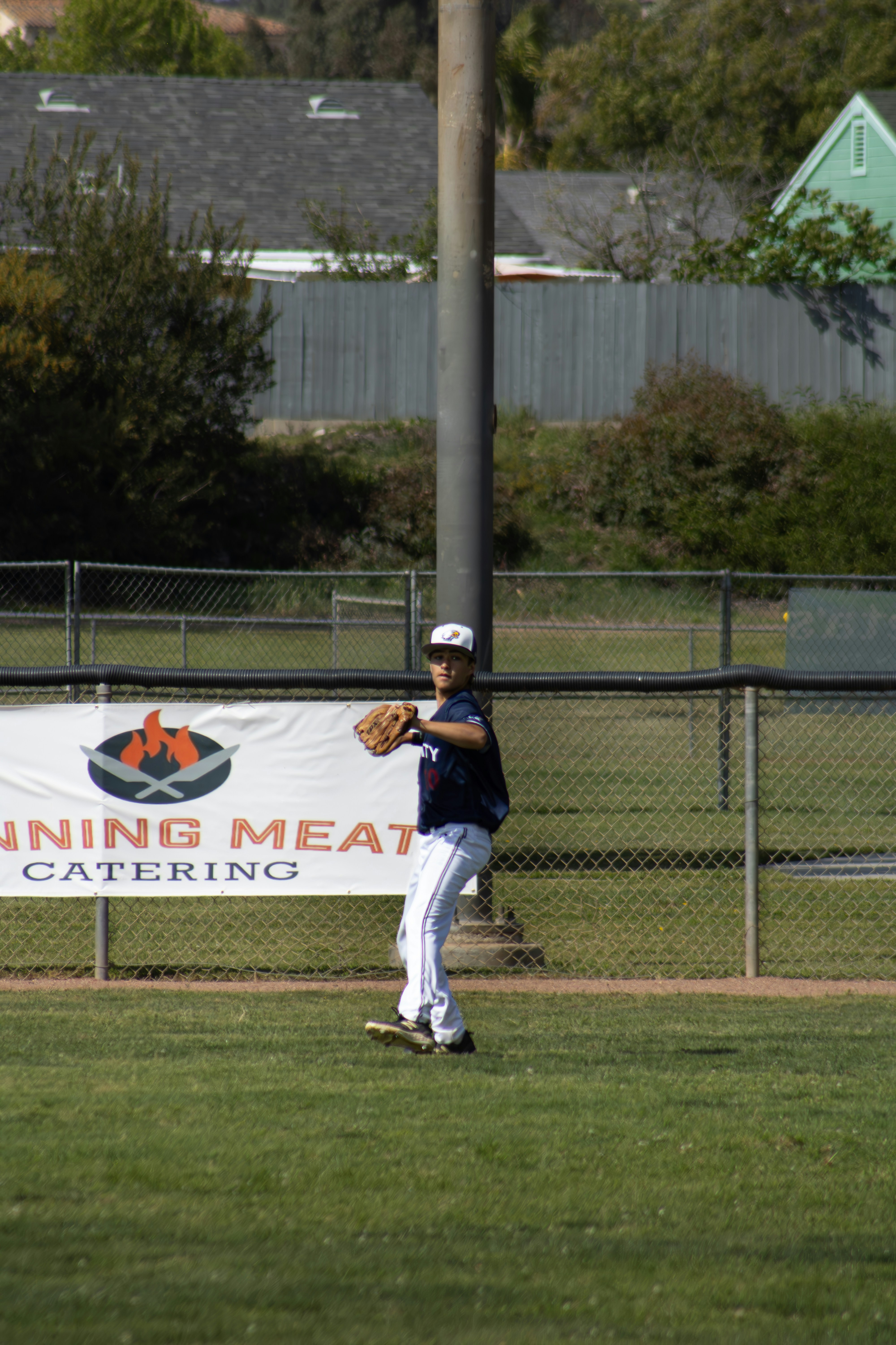 Glove Ready: Youth Baseball Player Anchors the Field Under Sunlit Sky