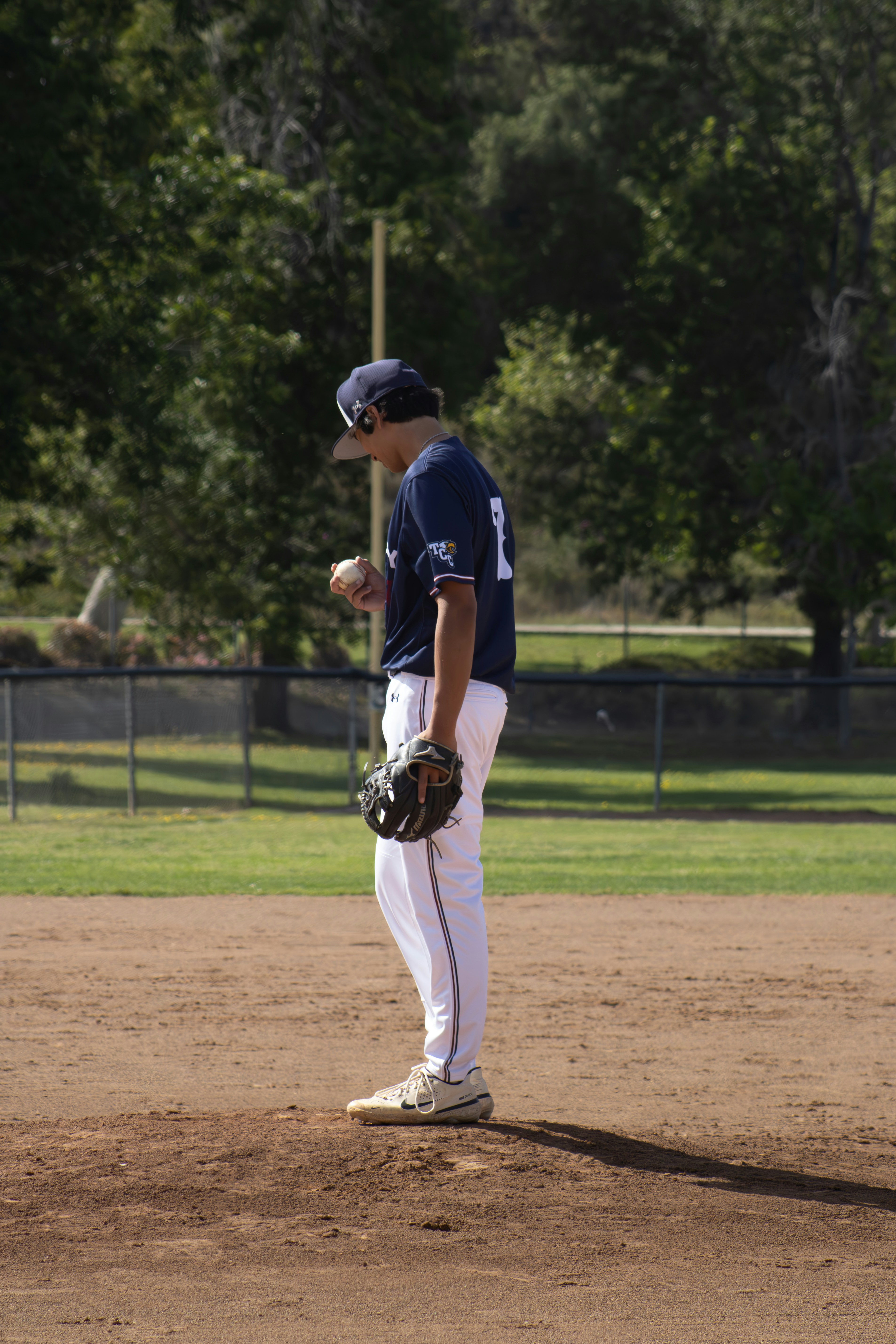 A baseball player stands on the pitcher's mound. photo – Free Image on ...