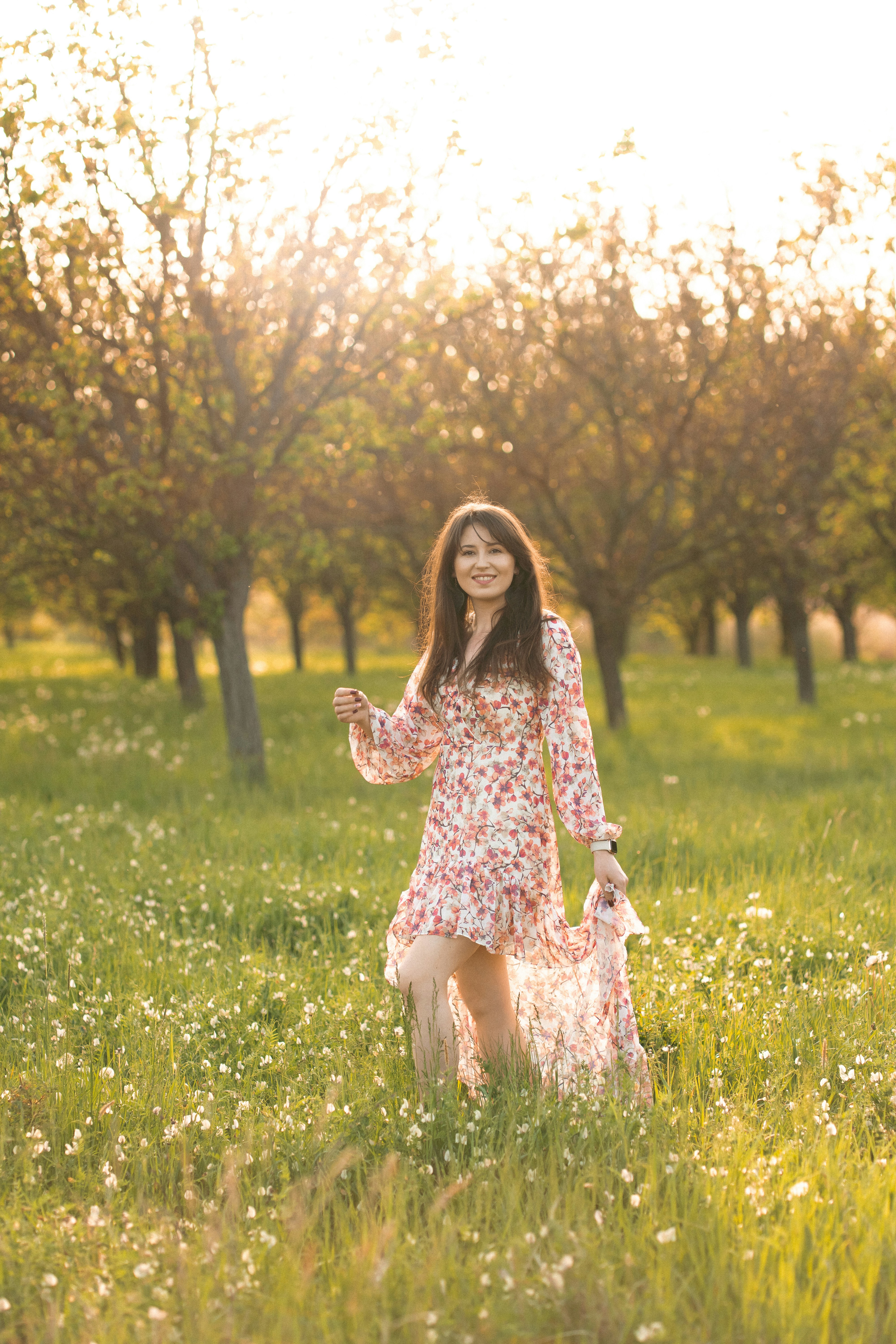 A woman frolics in a field during golden hour. photo – Free Woman Image ...