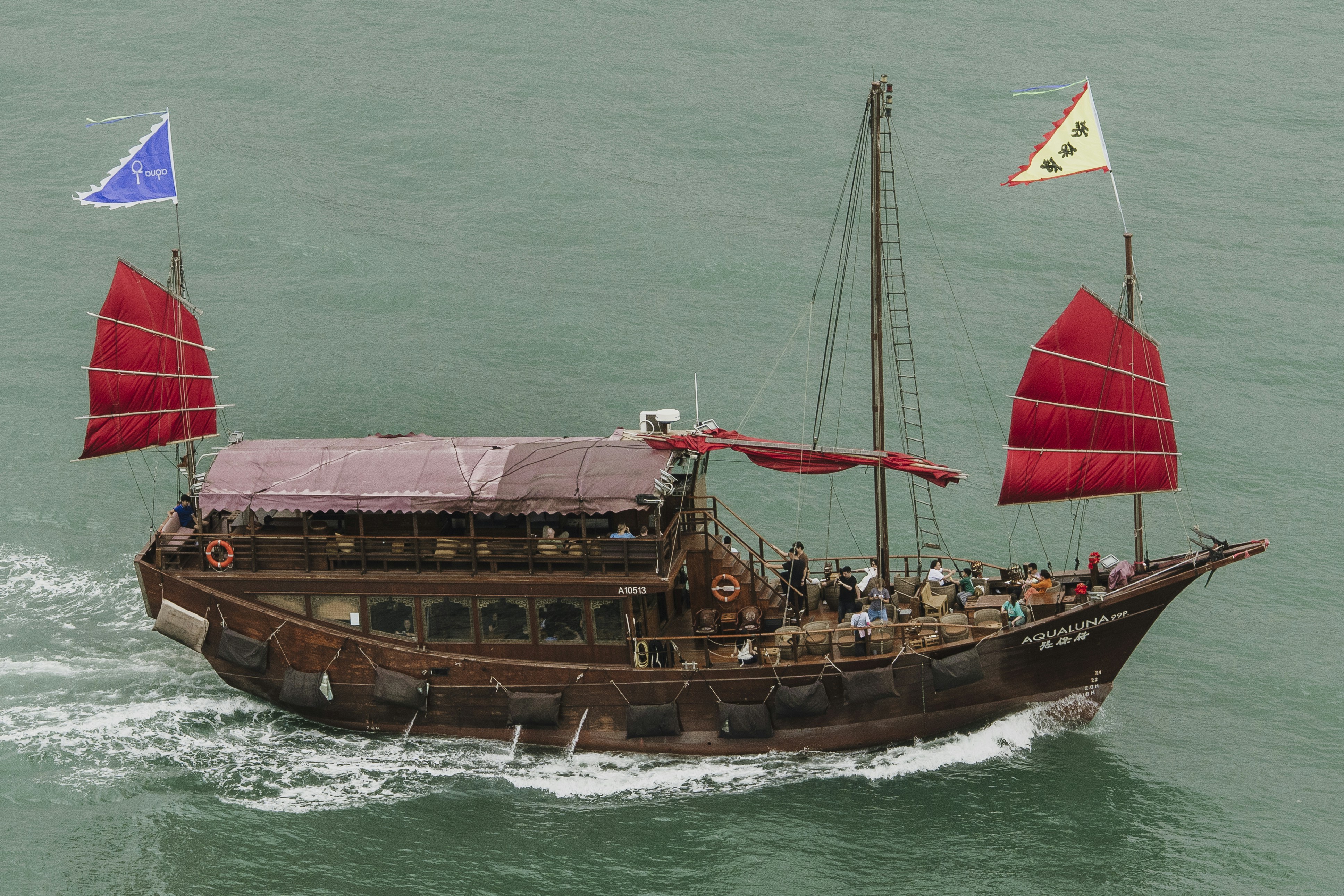 A wooden junk boat sails across the water. photo – Free Hong kong Image ...