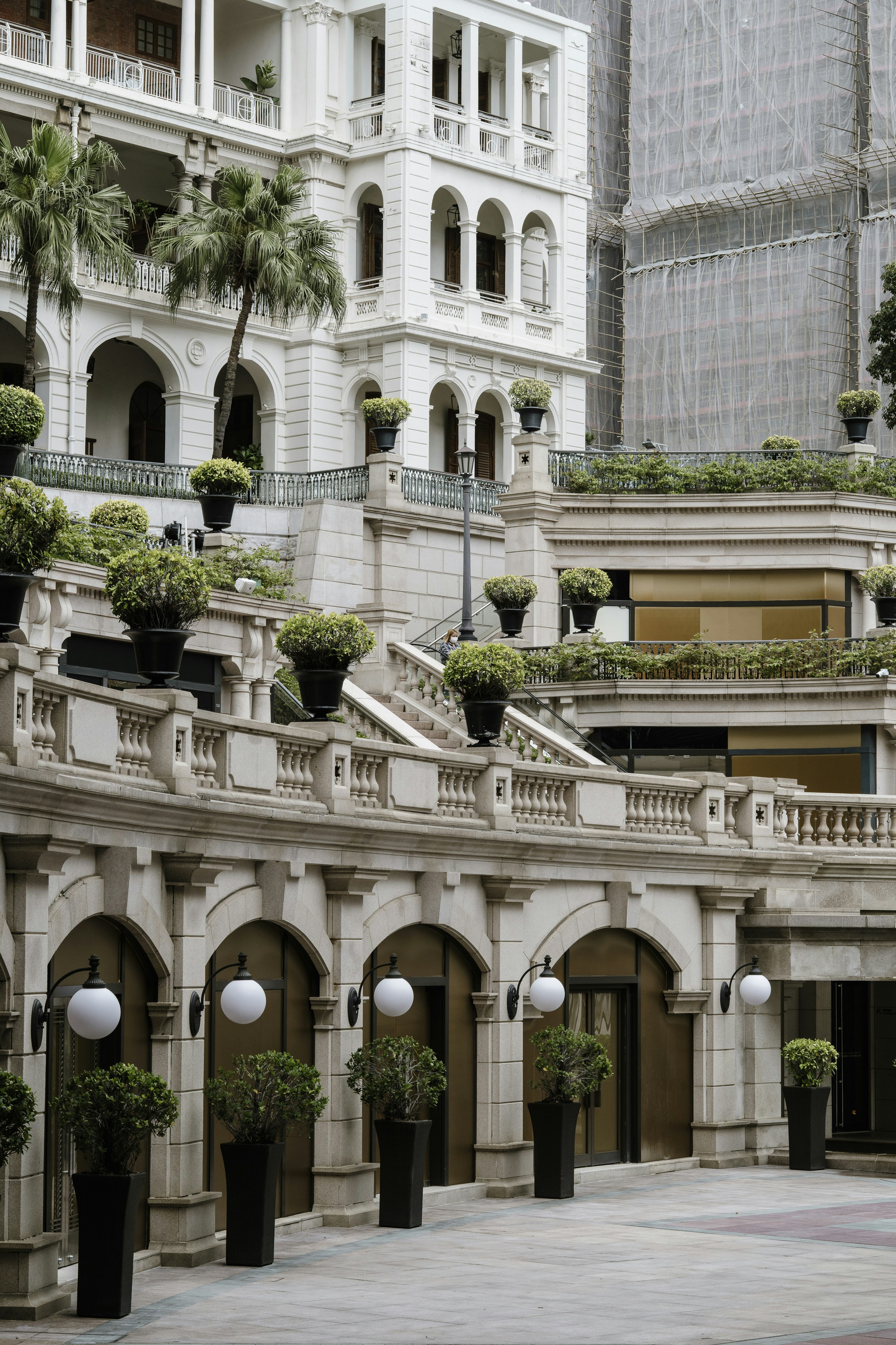 Terraced Arcades and Palm-Framed Staircase: A Quiet Grandeur