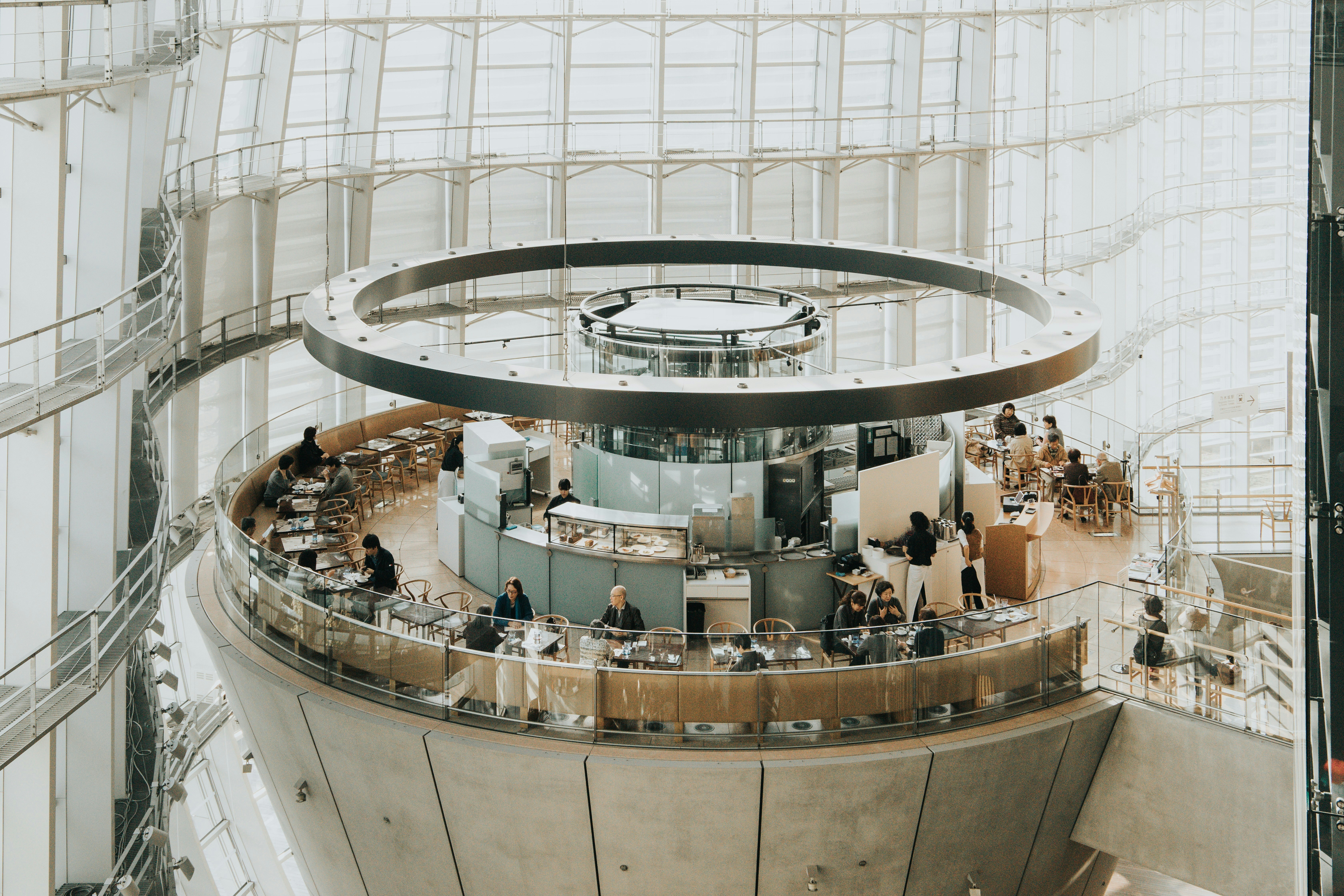 A modern cafe is situated inside a large structure. photo – Free ...