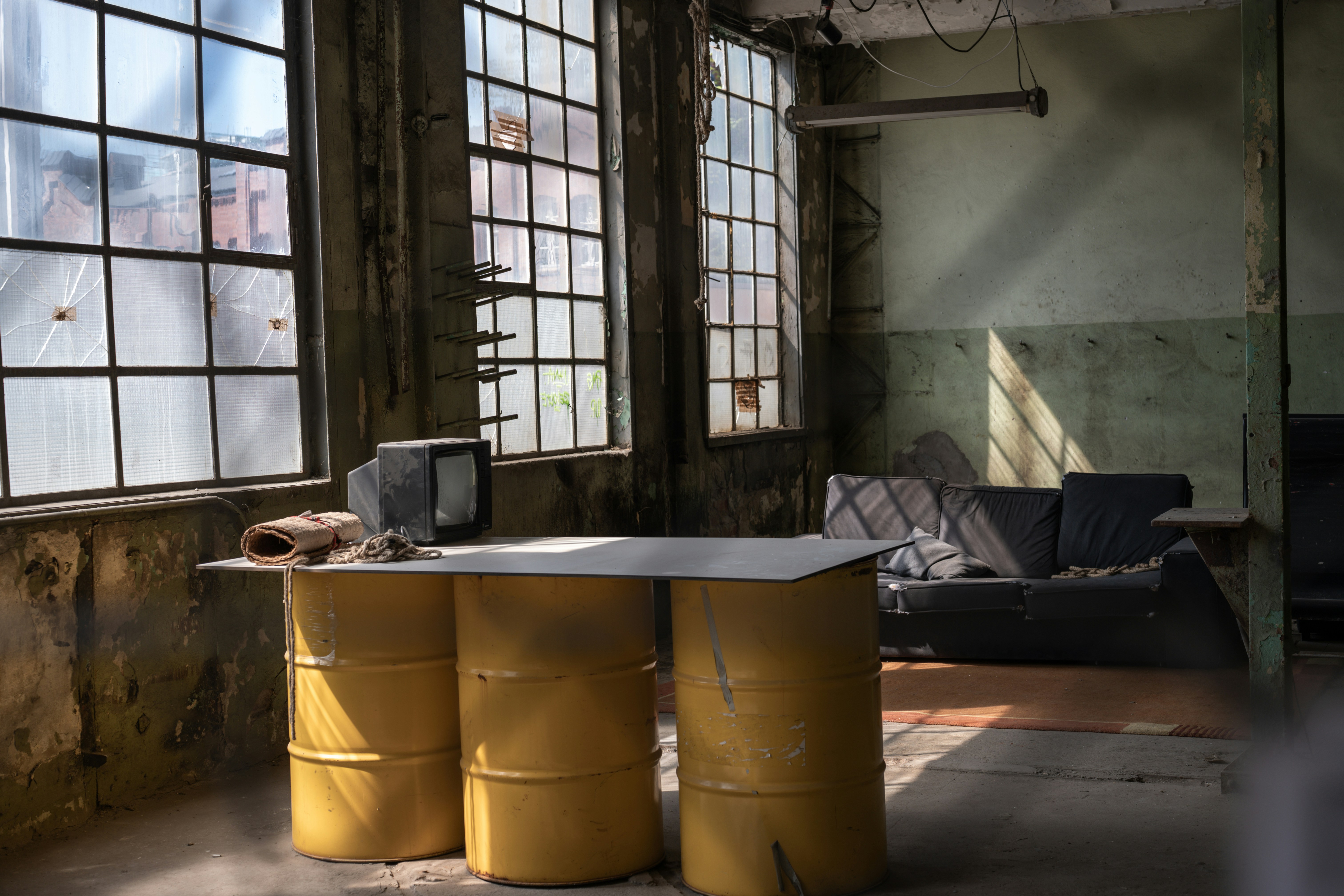 Sunlit Barrel Table: Quiet Drama in a Dilapidated Workshop