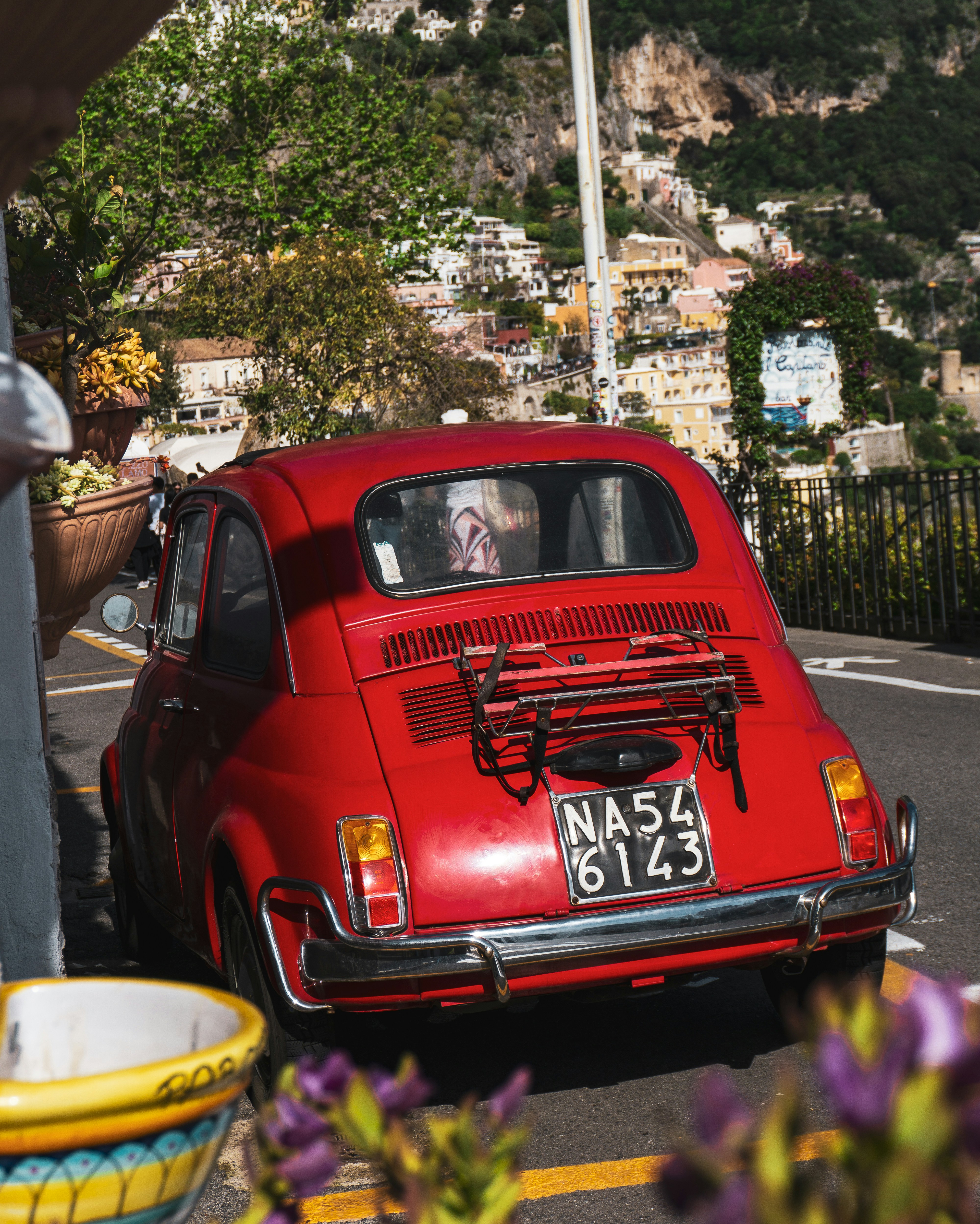 Crimson Fiat 500 on a Cliffside Street: Portrait of Italian Charm