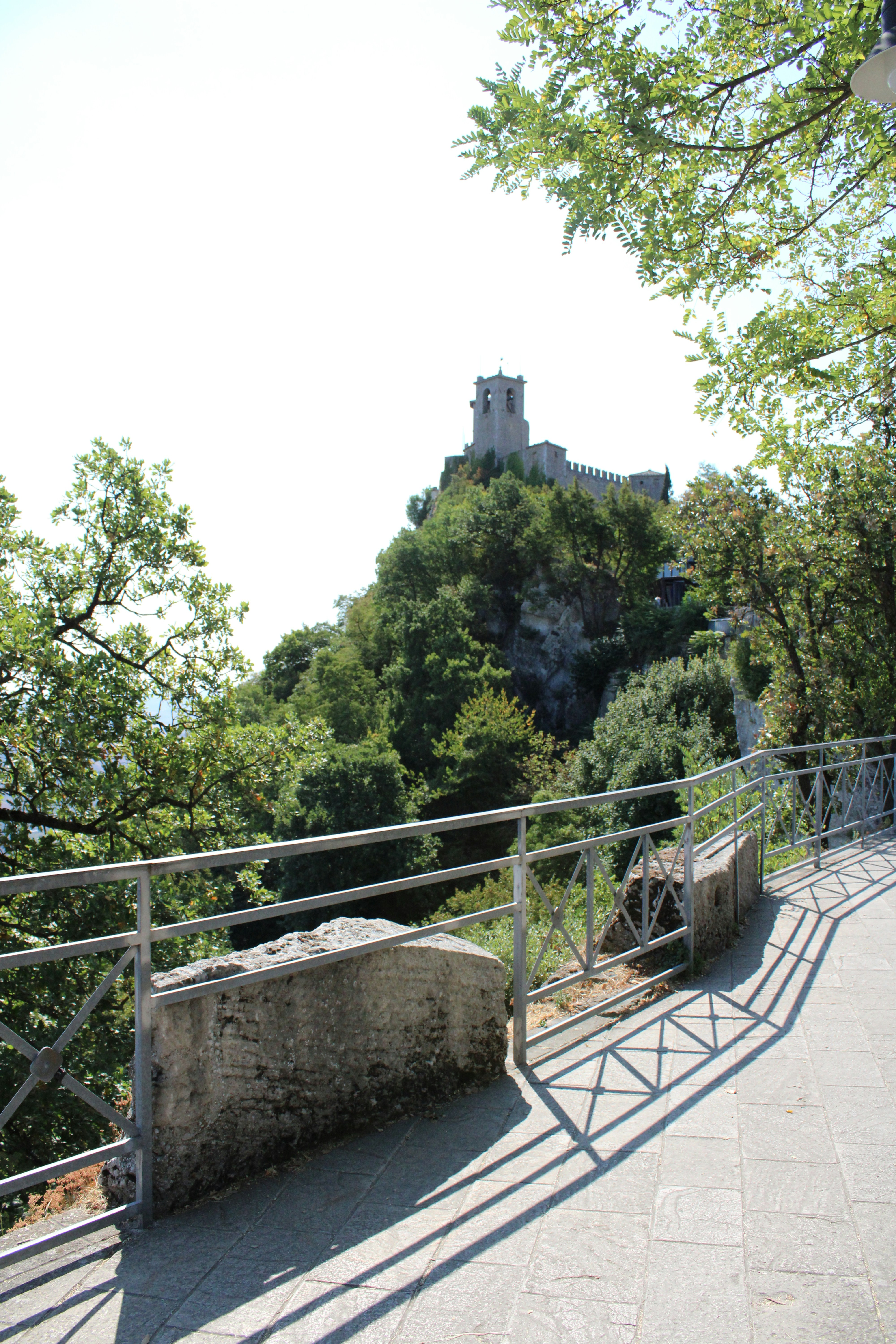 Horizon Fortress Rising Above a Tree-Lined Cliffside Path