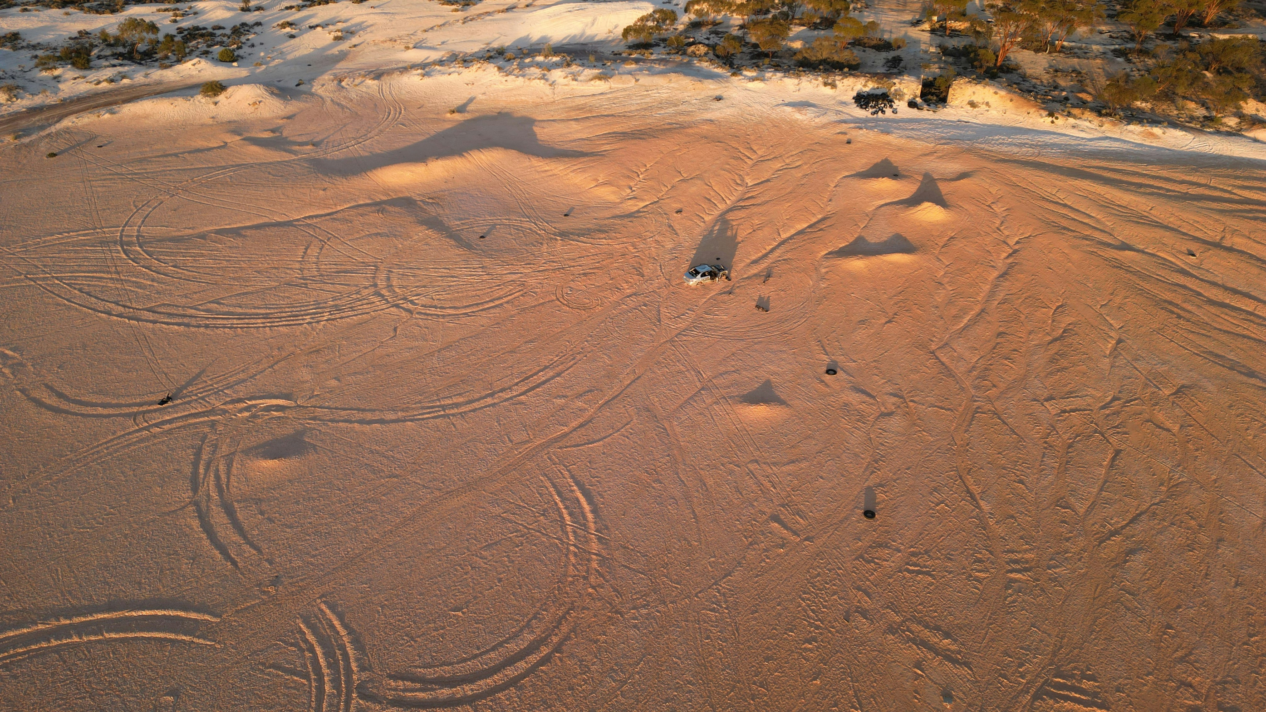 An abandoned car on a dried river bed