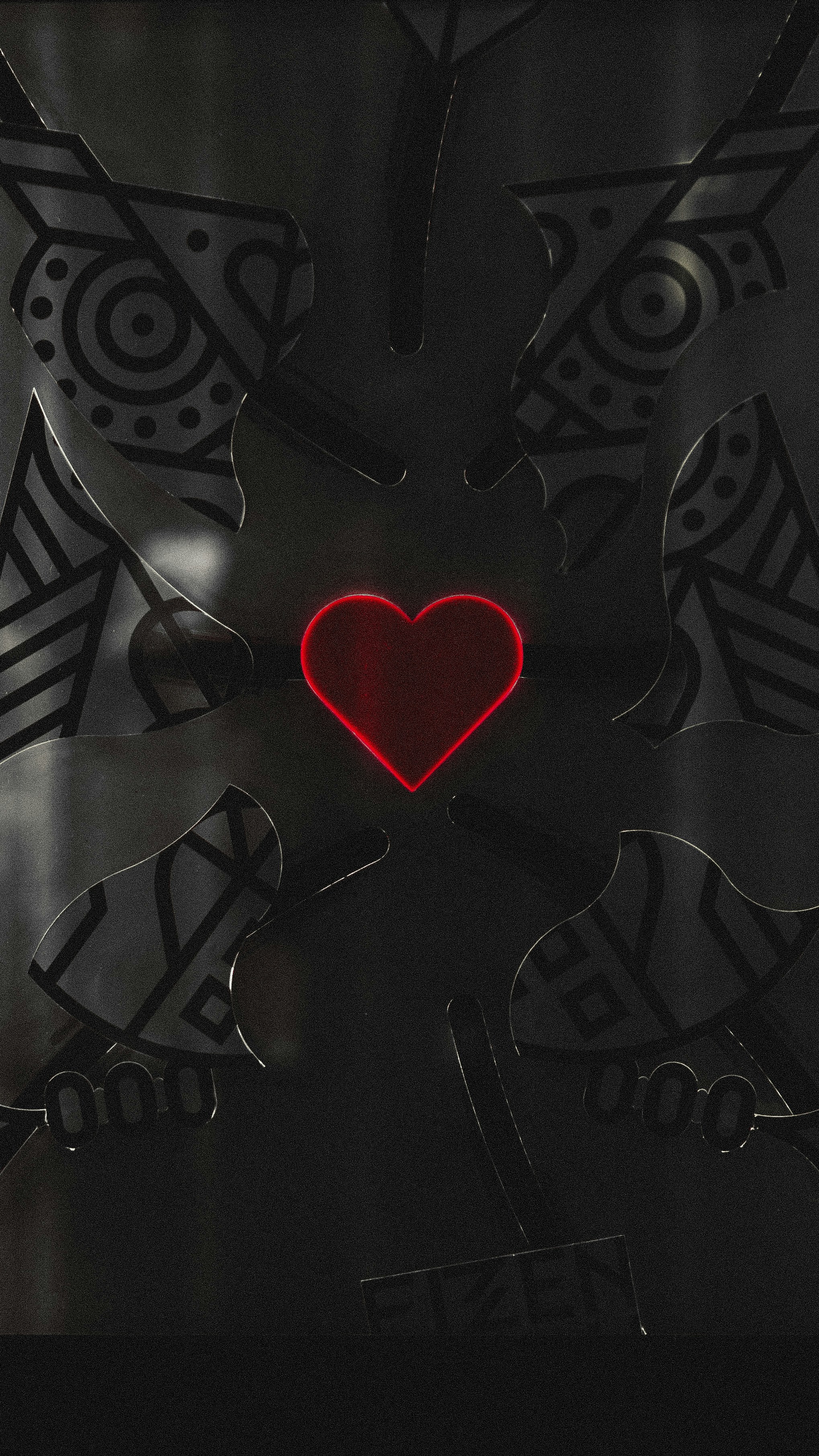 A glowing heart surrounded by figures with patterns.