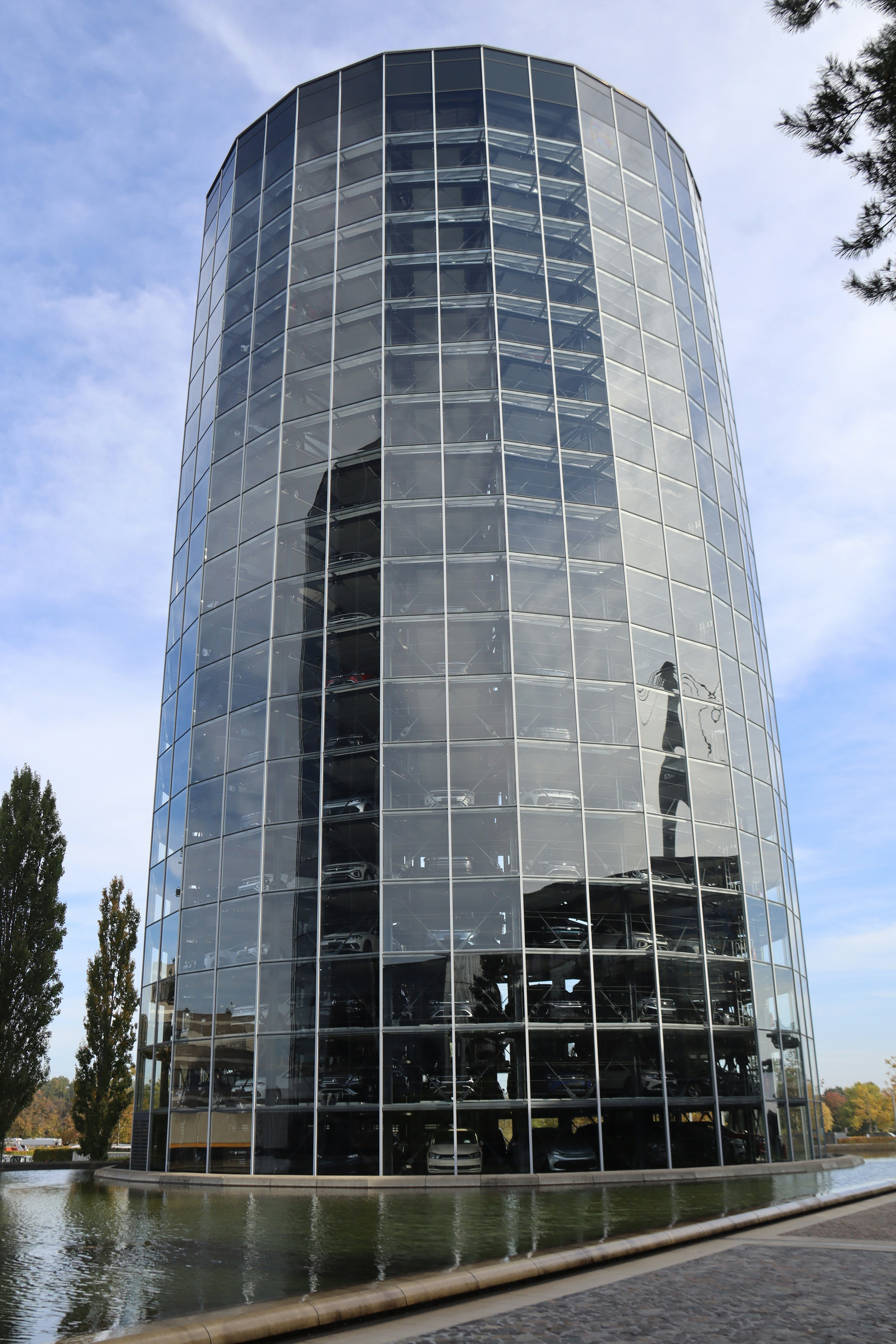 A tall, cylindrical building with glass panels. photo – Free Germany ...