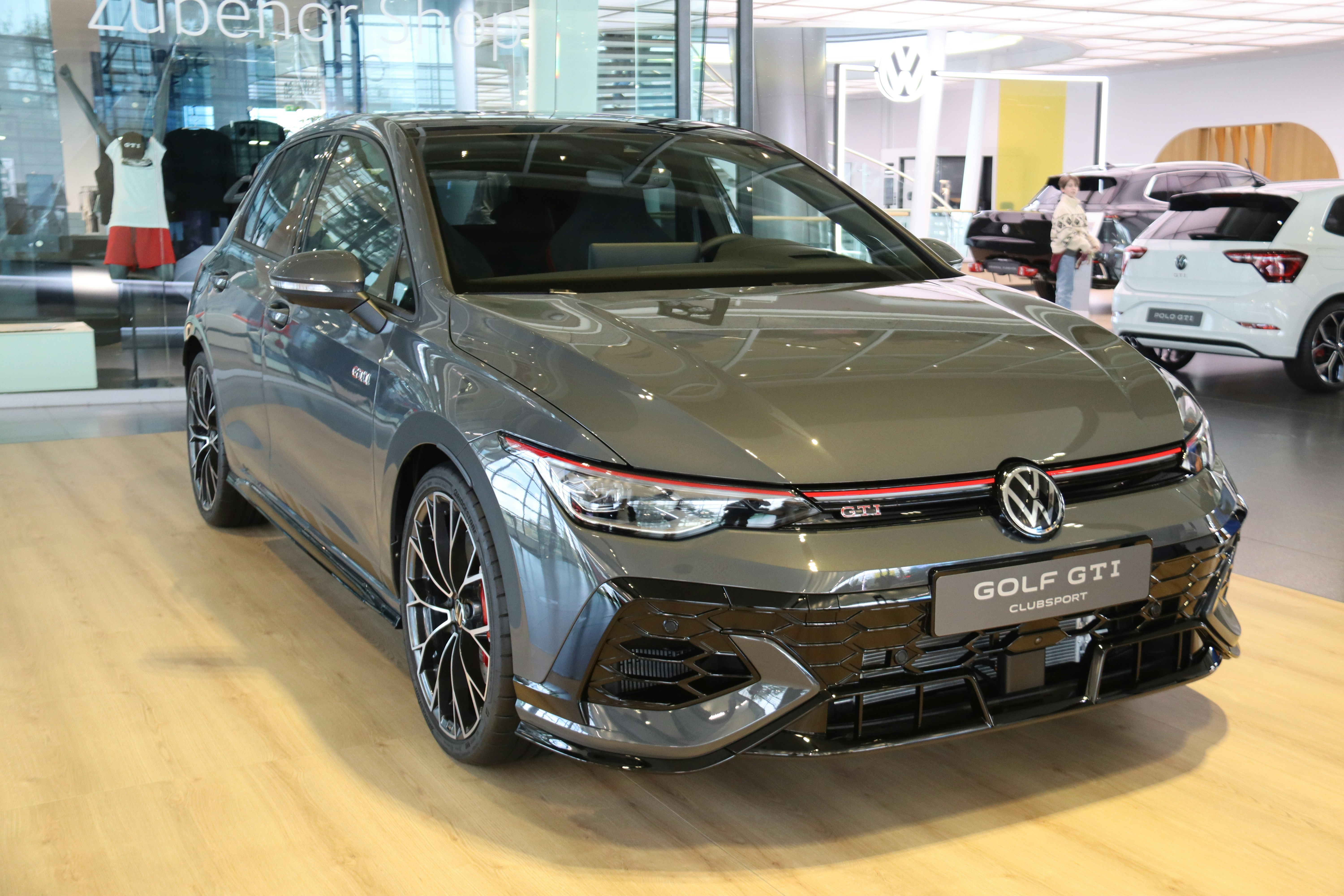 A grey volkswagen golf gti sits in a showroom. photo – Free Germany ...
