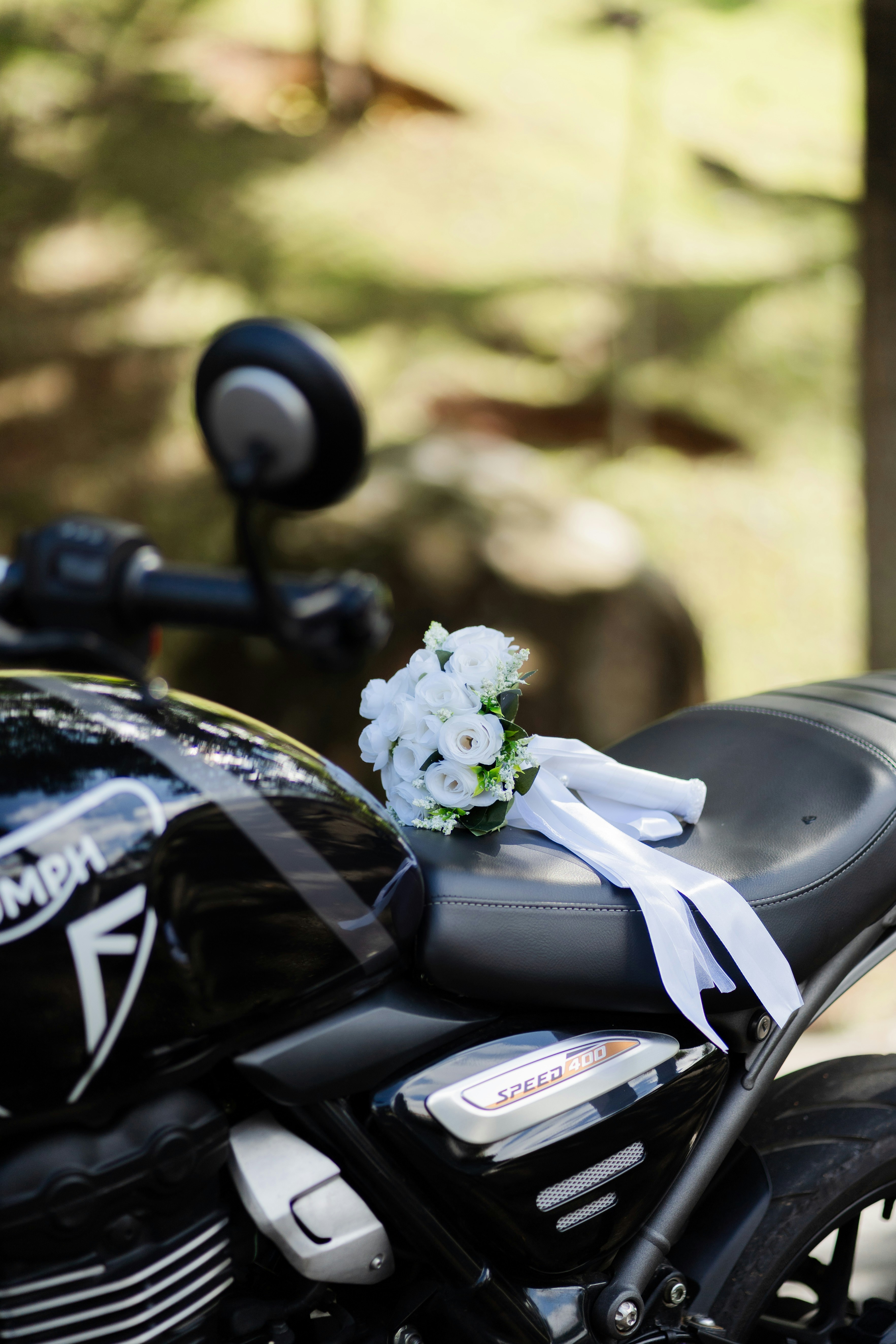 White Bouquets on a Black Triumph: A Quiet Wedding Moment on the Motorcycle