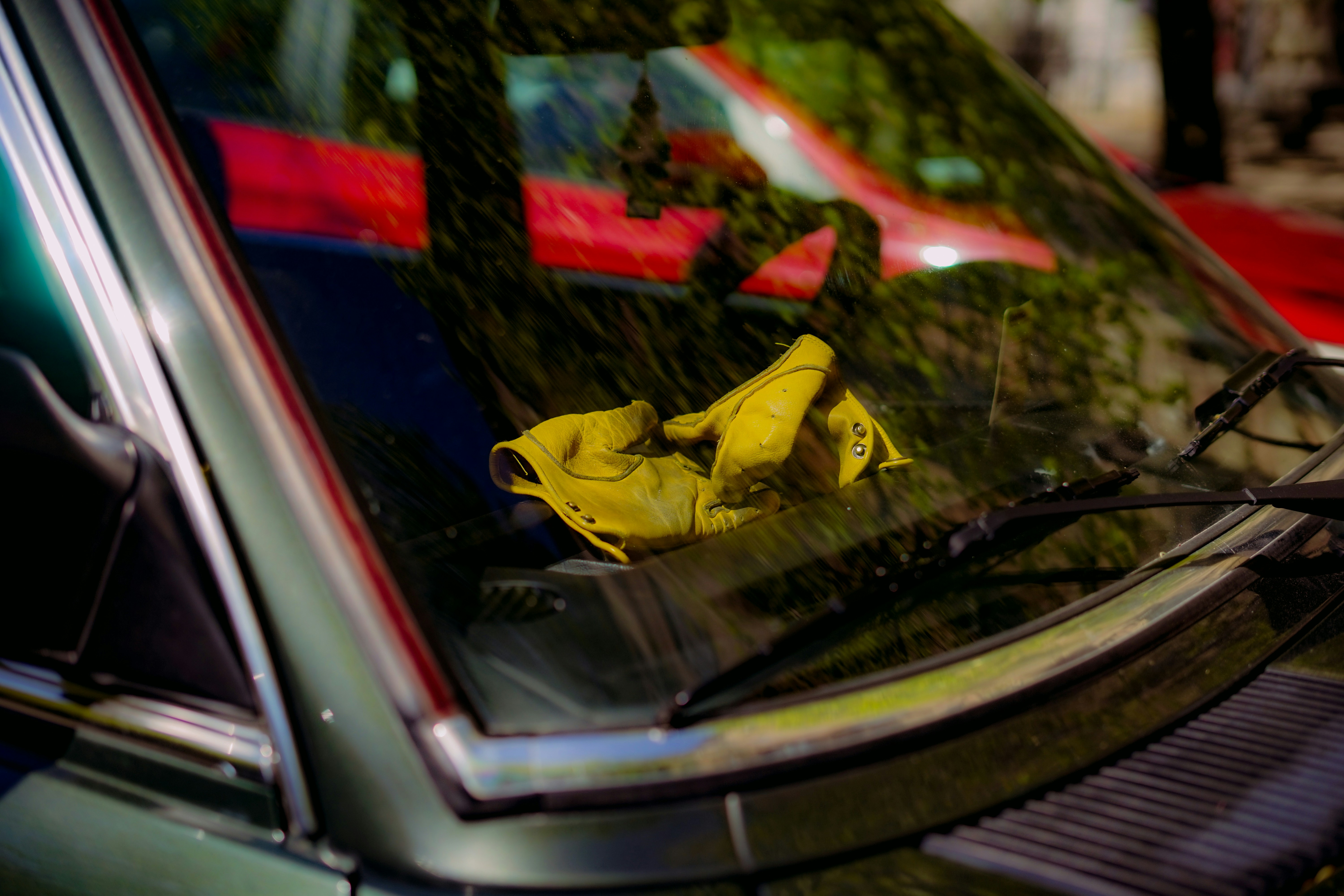 Yellow Glove on Glass: a Quiet Moment Inside a Weathered Car