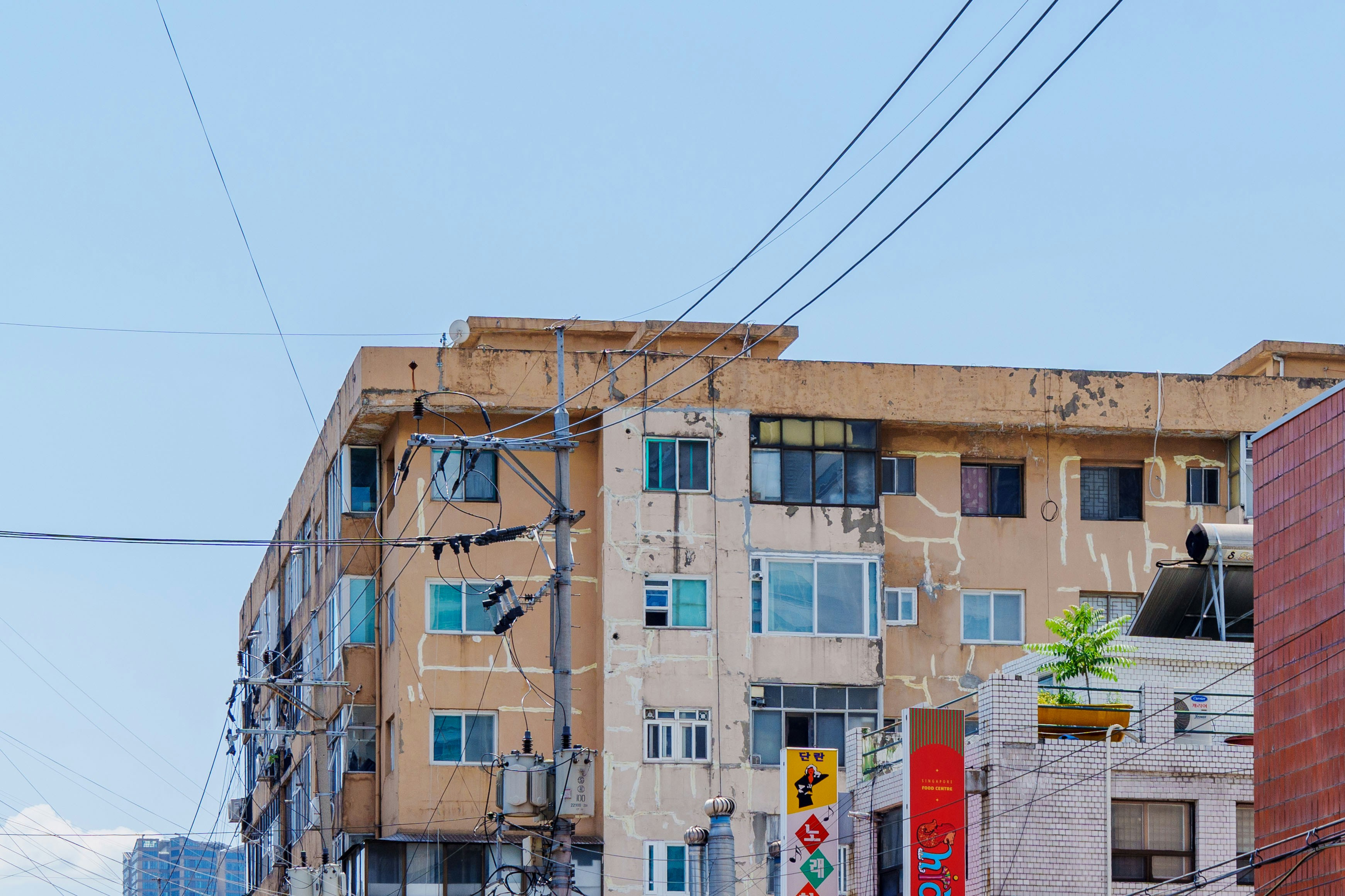 Urban Facade Echoes: A-City Scene with Wires and Warm Tint