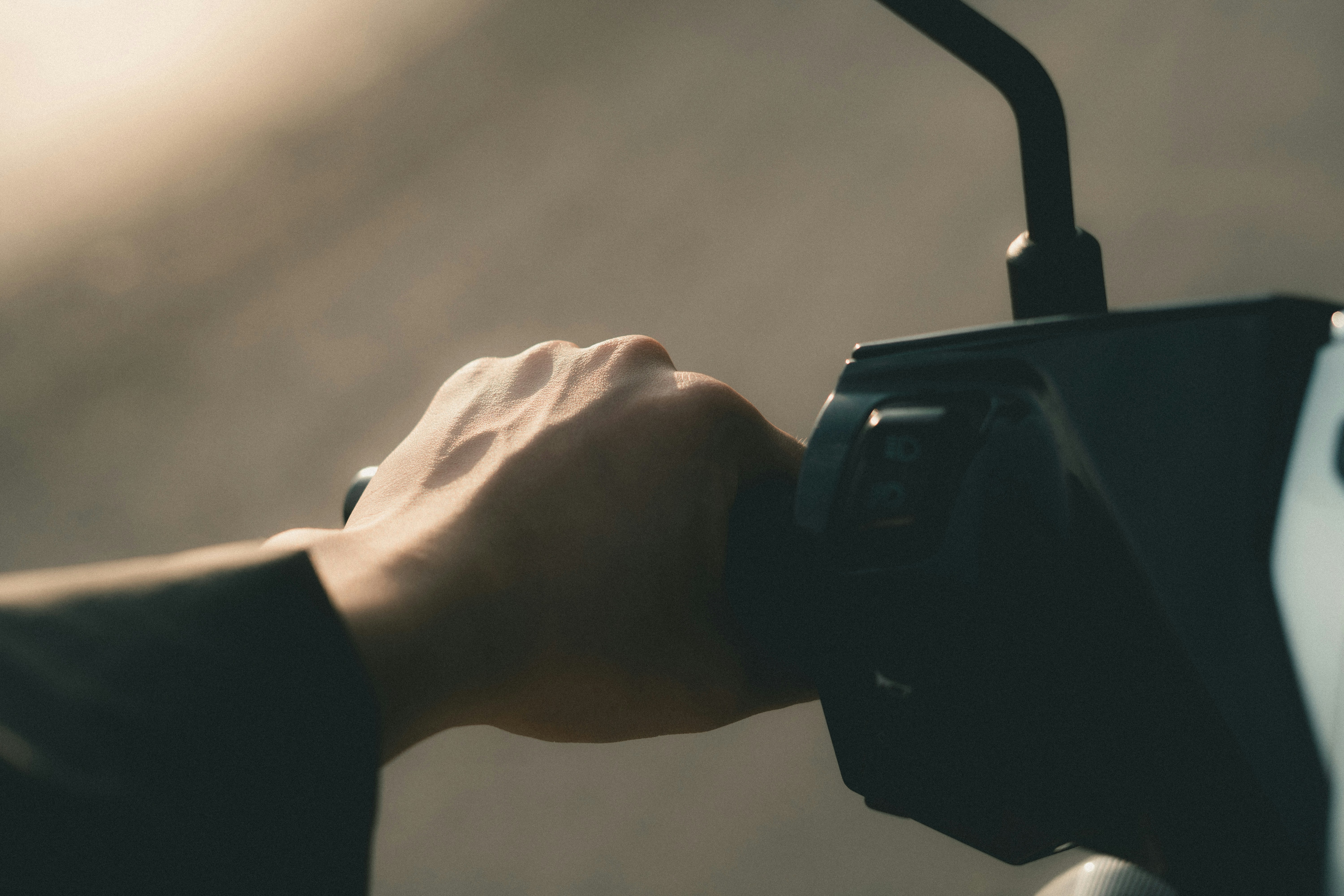 Grip on Momentum: Close-Up of a Hand on the Motorcycle Throttle