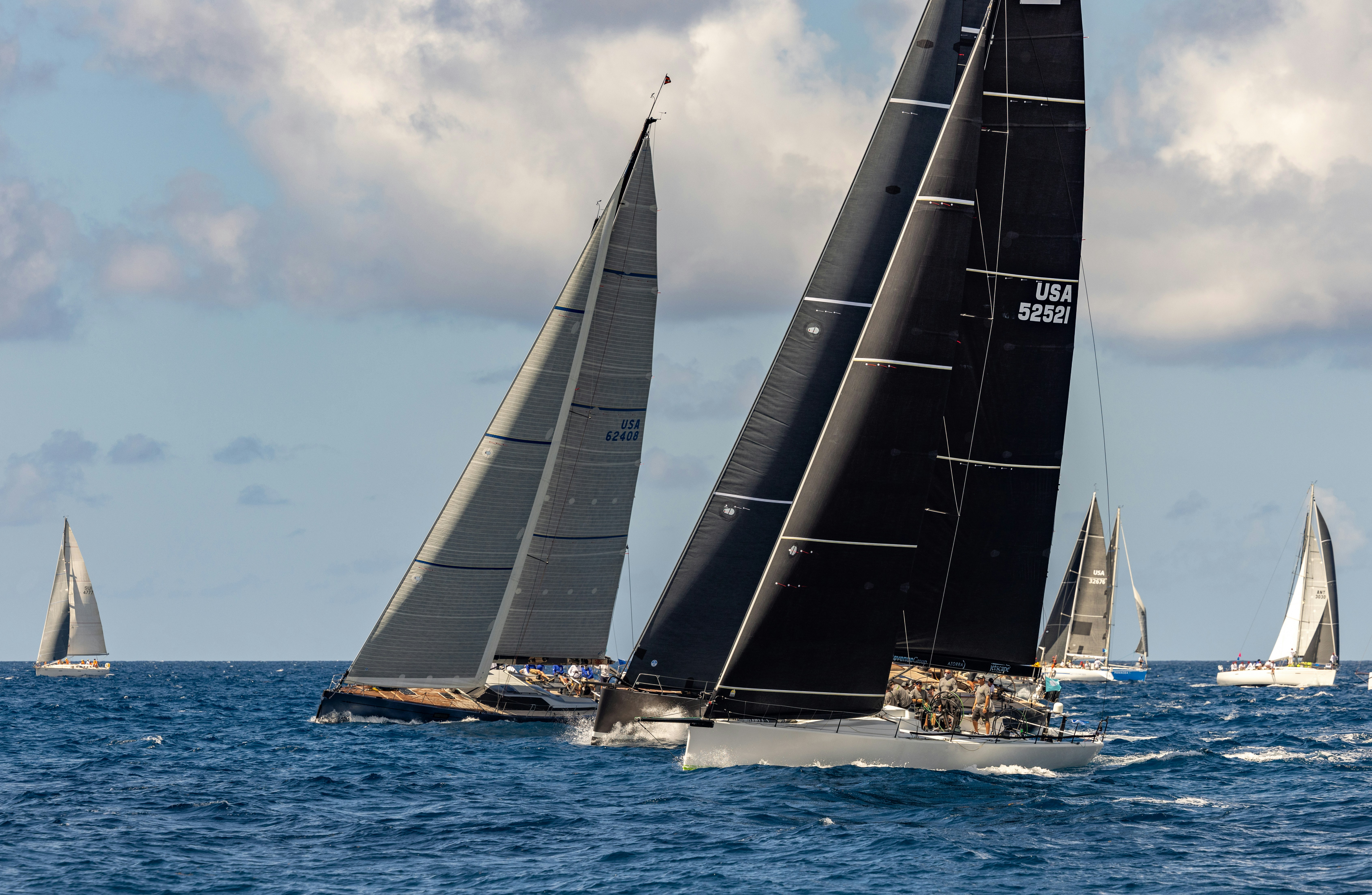 Sailing yachts race across the ocean waters. photo – Free People Image ...