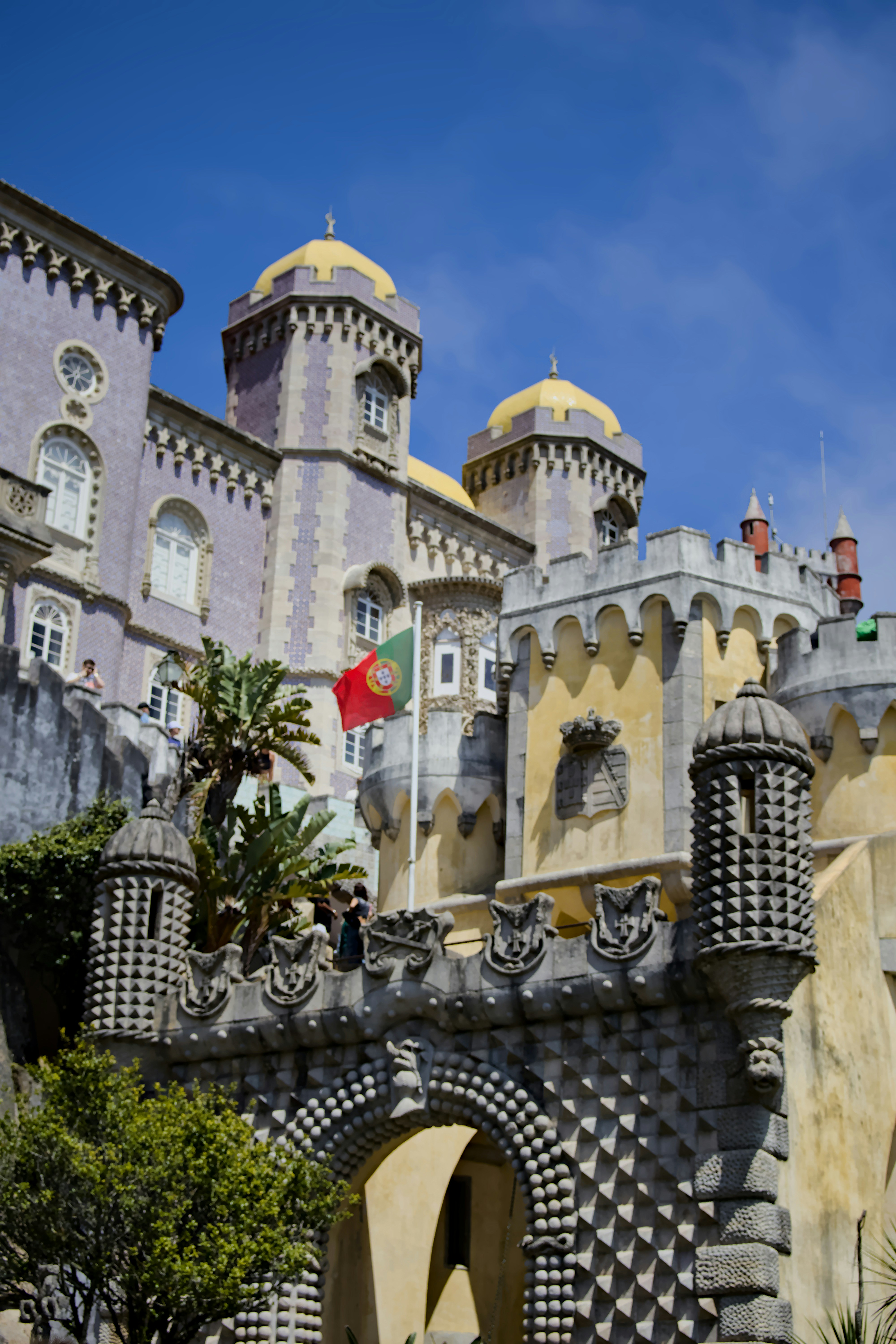 Pena Palace's Crowned Turrets: Purple Facades, Golden Domes, and a Basalt Arch