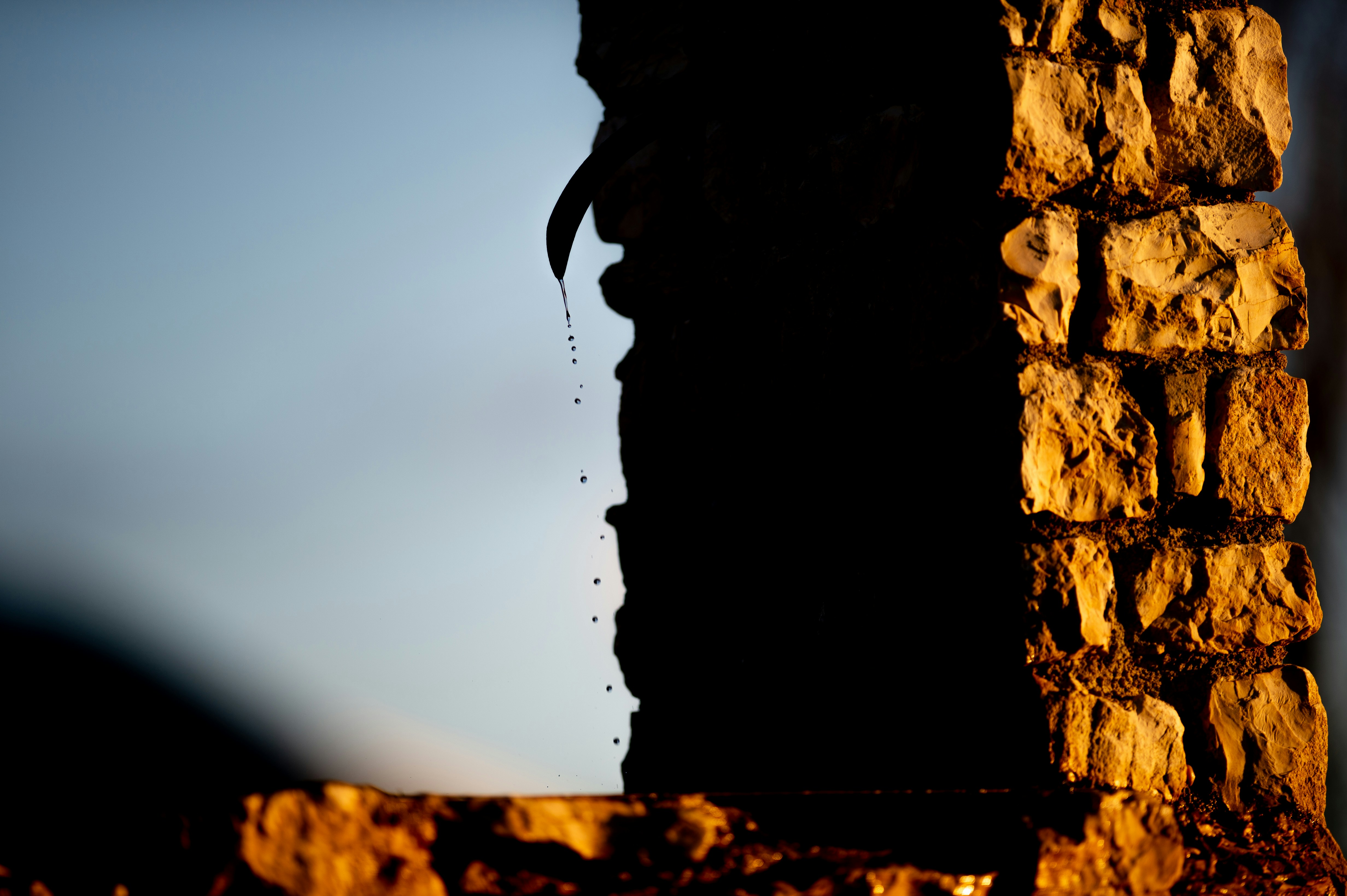 Sunlit Stone Wall with Morning Water Droplets