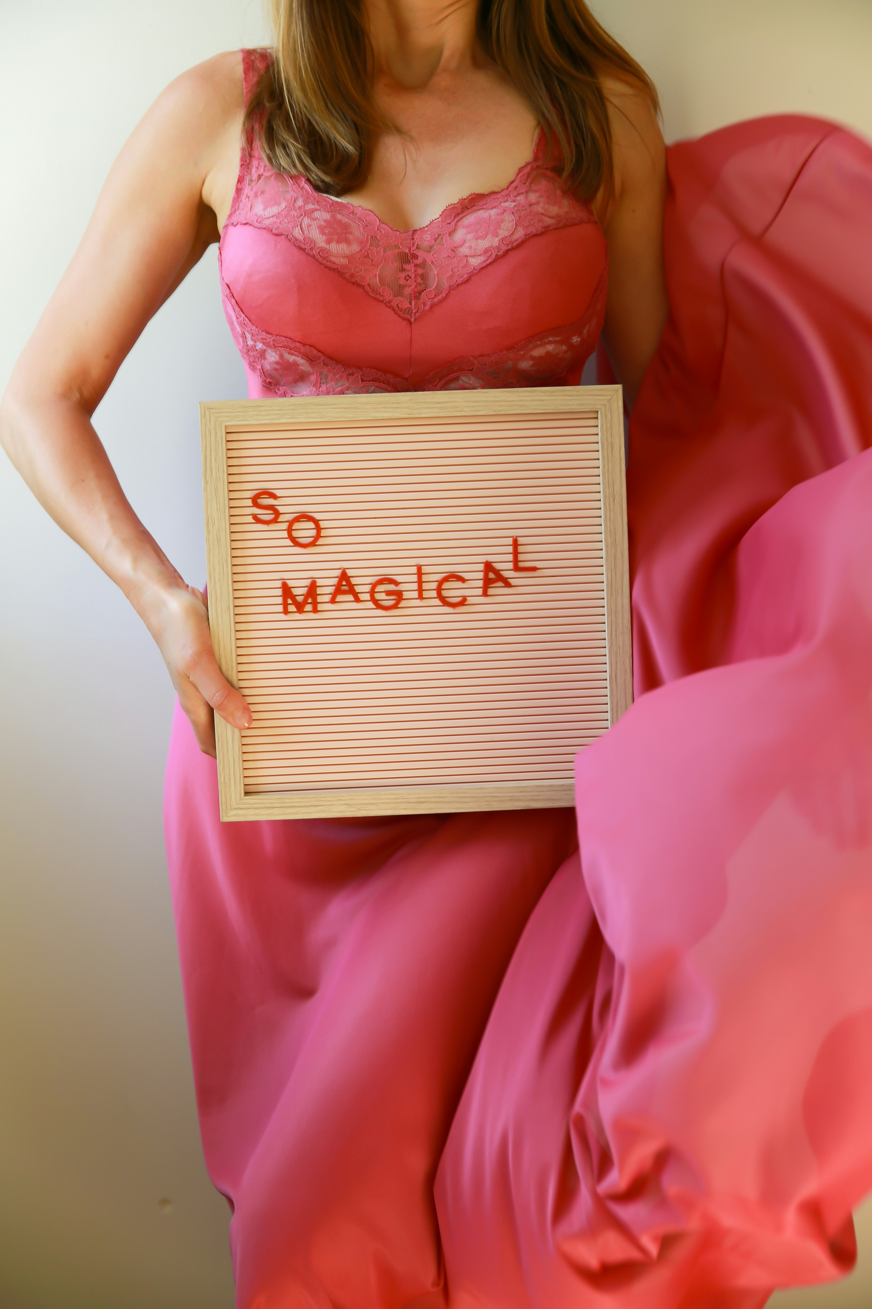 Woman in pink holds a sign saying "so magical". photo – Free Woman ...