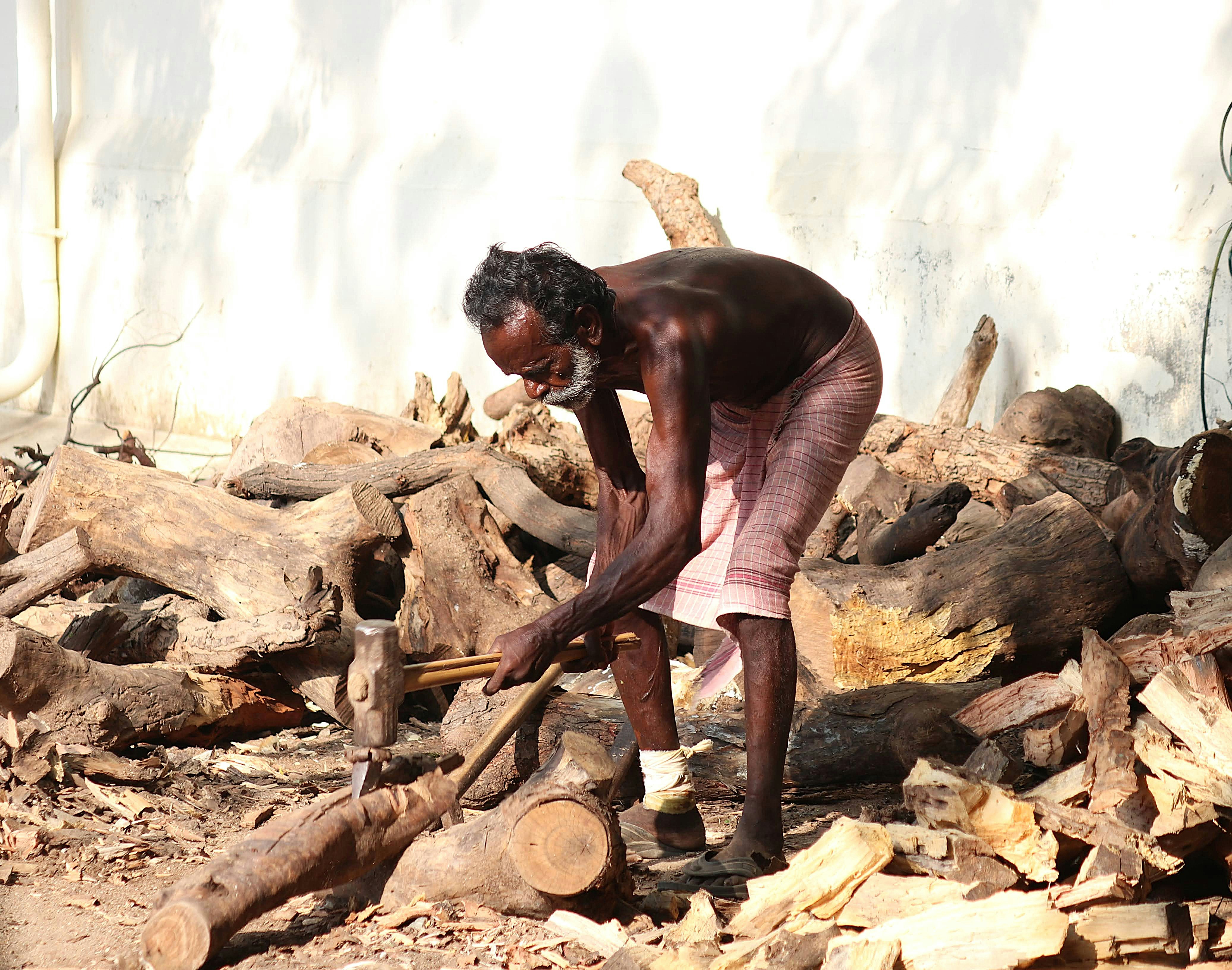 Sunlit Labor: The Axe Swing Over a Pile of Firewood