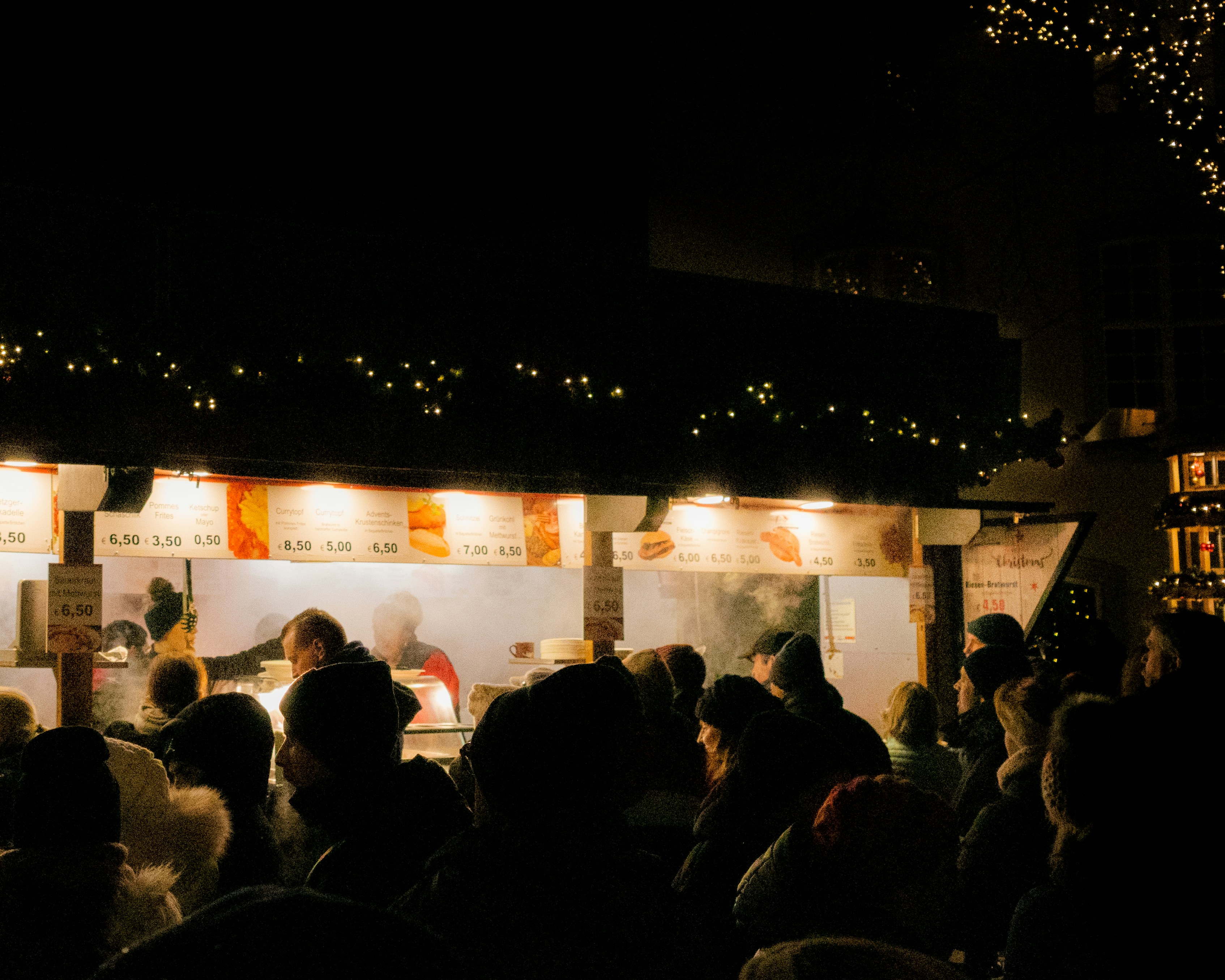 People gather at a food stall at night. photo – Free Christmas Image on ...