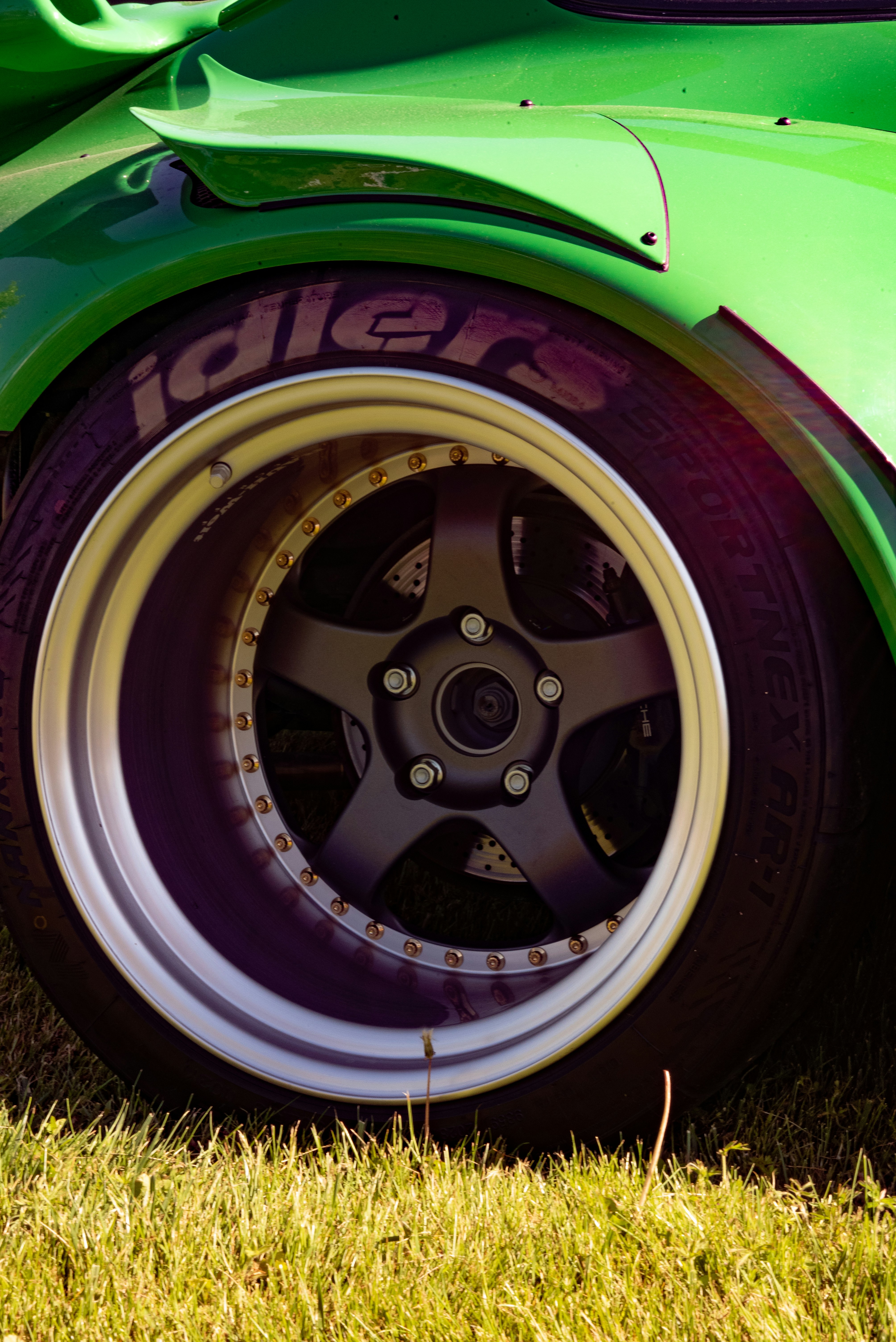 Lime-Green Velocity: close-up of a gold-rim wheel on a vivid green sports car