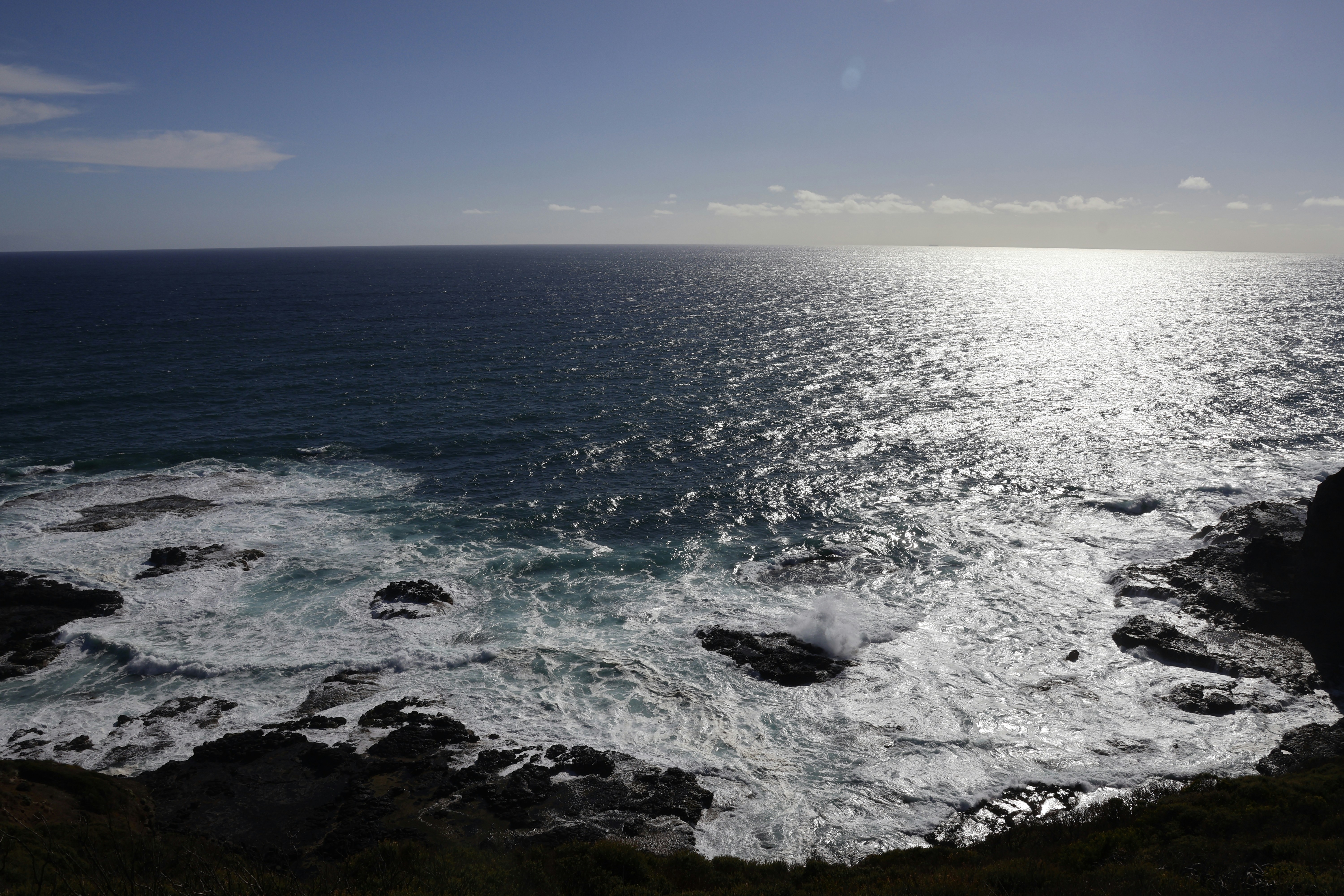 The waves of the endless ocean, roaring continuously as they hit the shore.