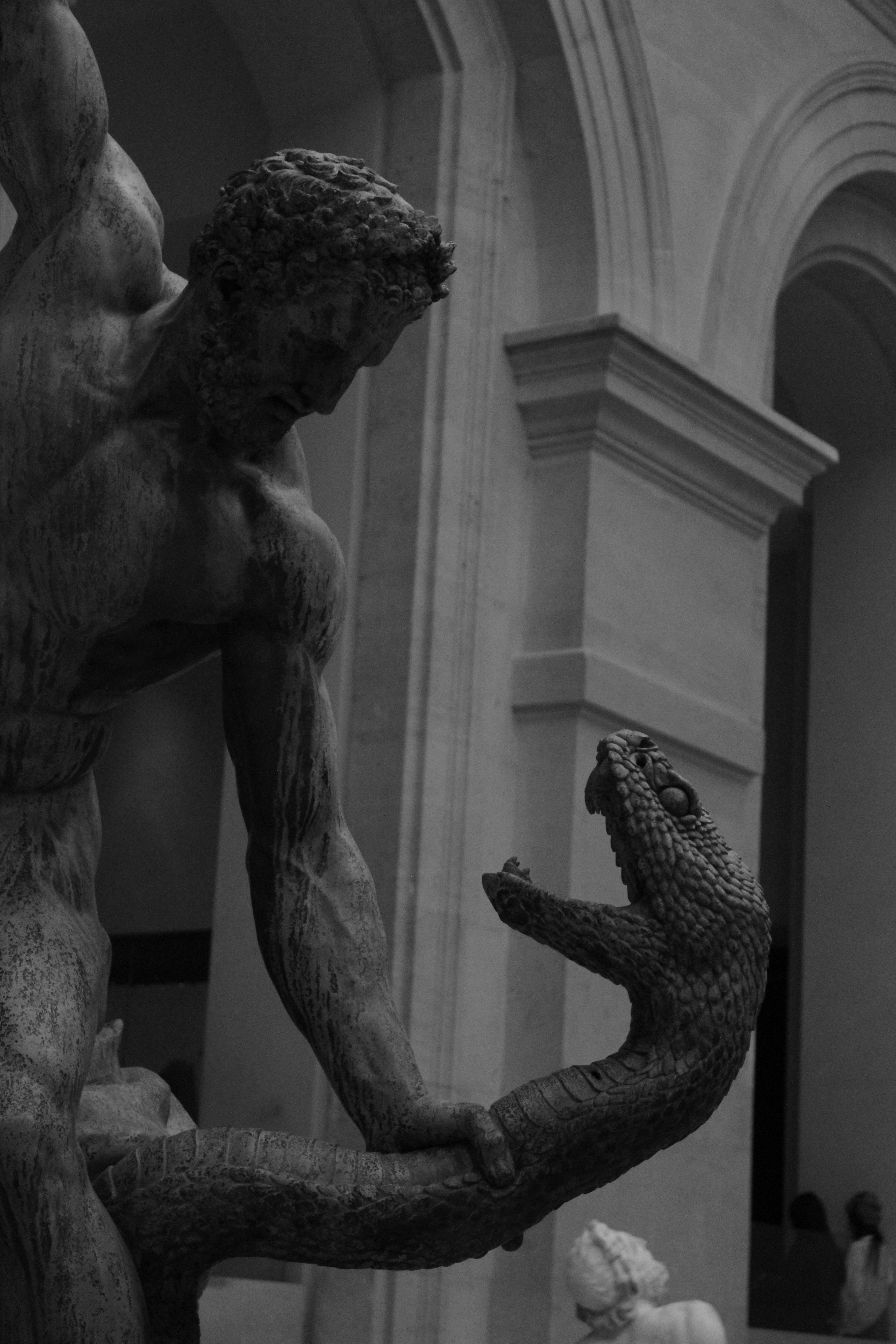 Marble Duel: A Muscular Gesture Grasping a Coiled Serpent Under an Archway