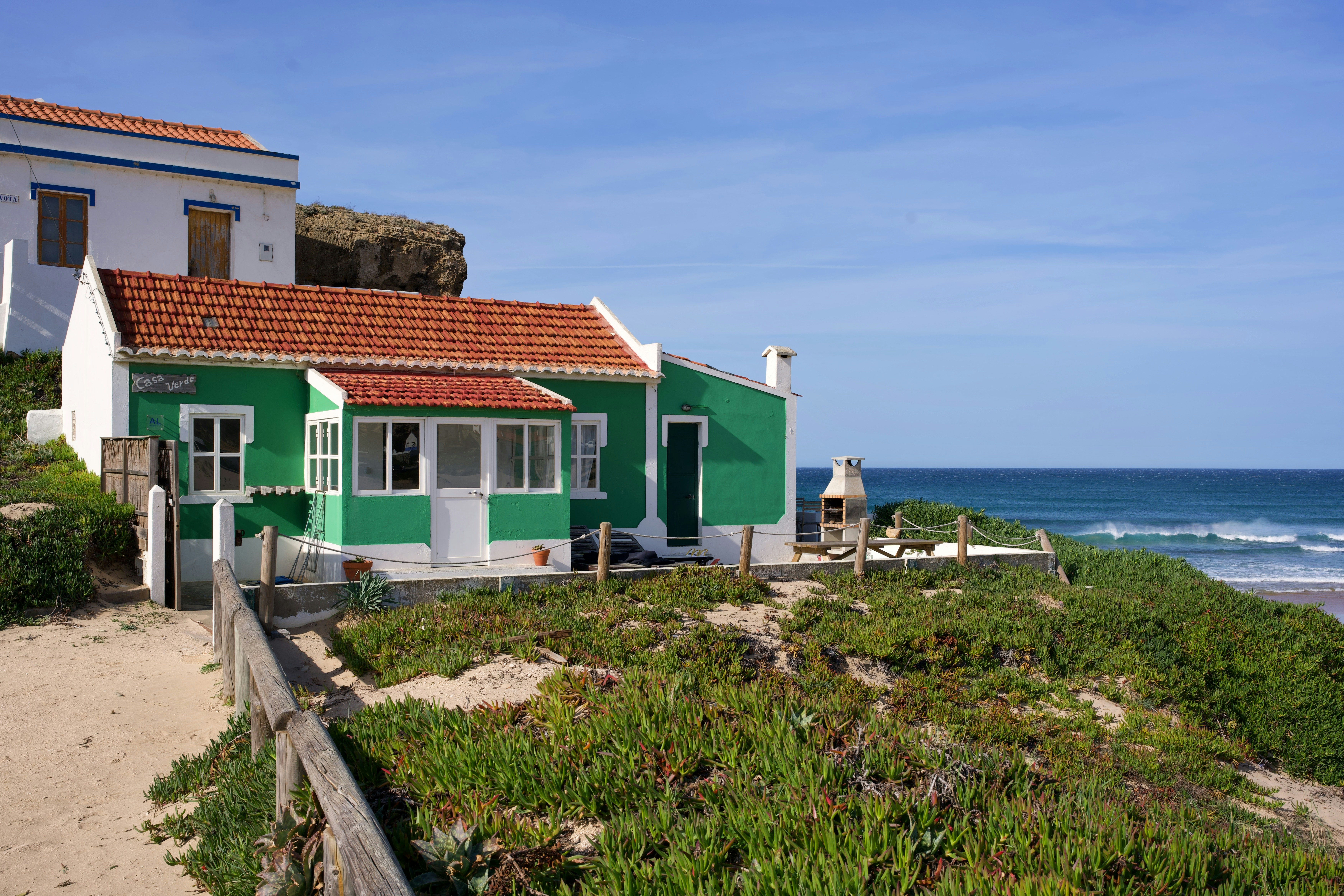 Verdant Seaside Cottage Anchored Along a Sunlit Dunes Path