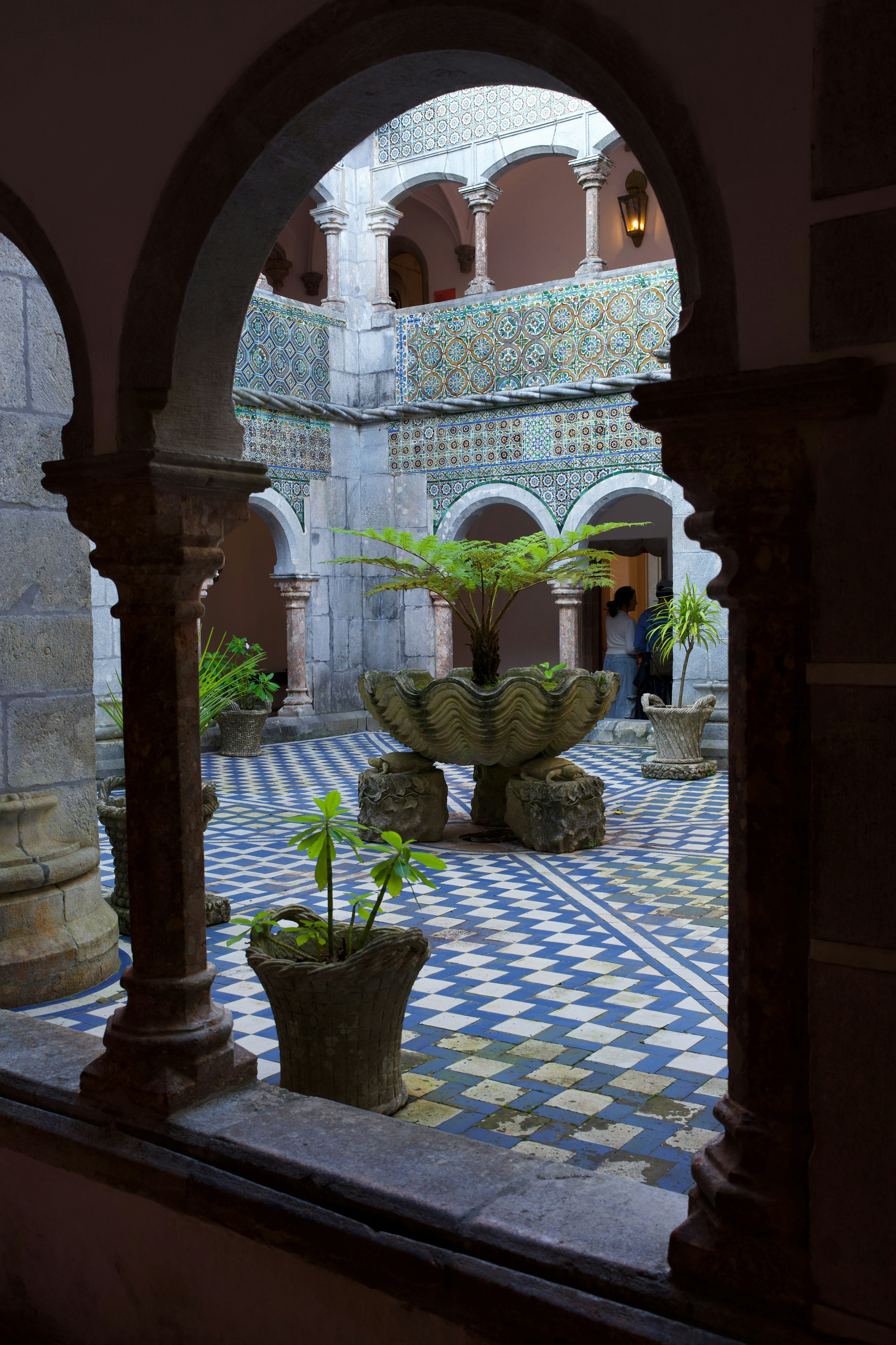 An ornate courtyard is seen through arched pillars. photo – Free Palace ...