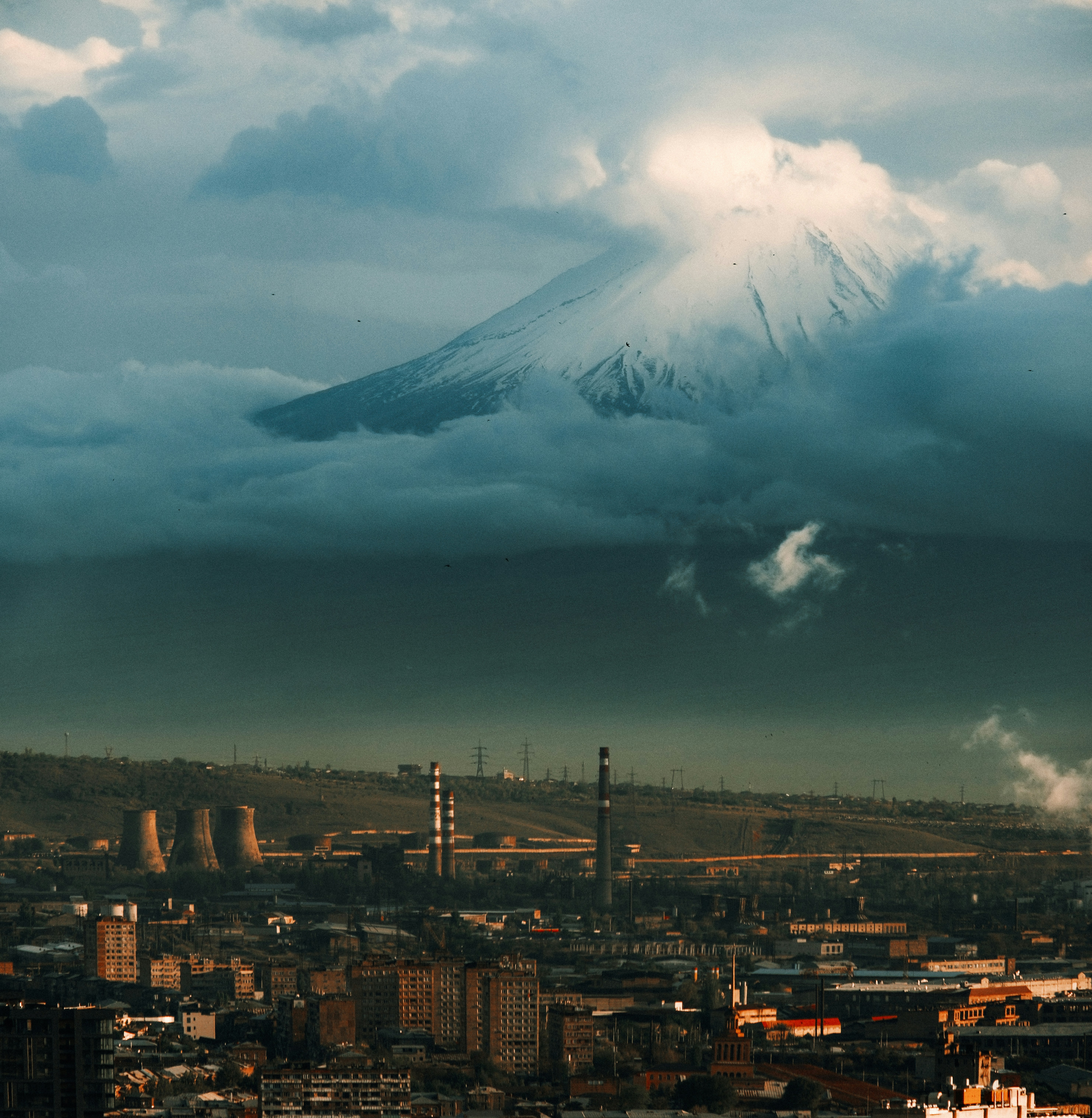 Snow-Capped Fuji Pierces the Clouds Over an Industrial Horizon