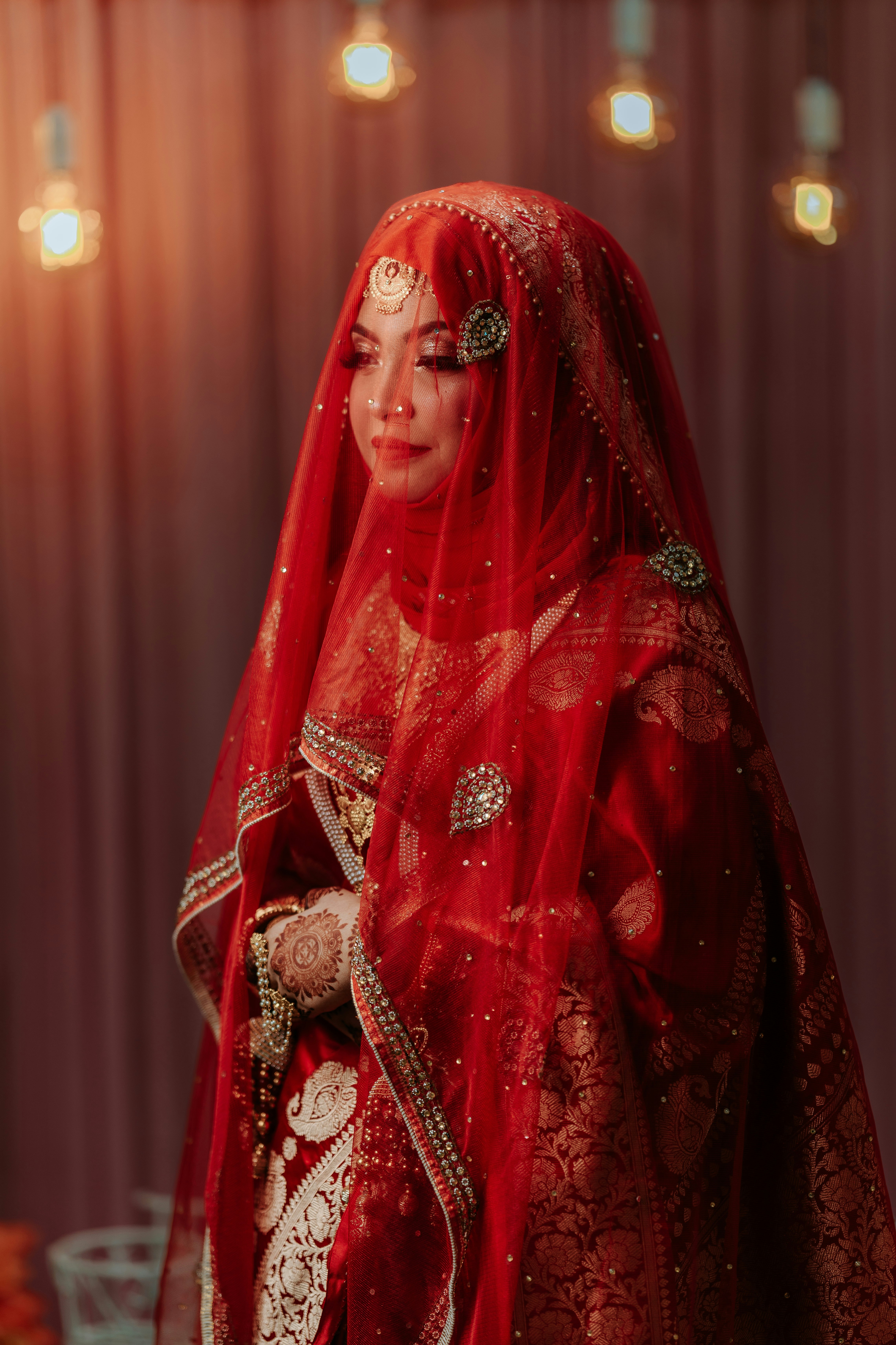 A bride is posing in beautiful red attire. photo – Free Image on Unsplash