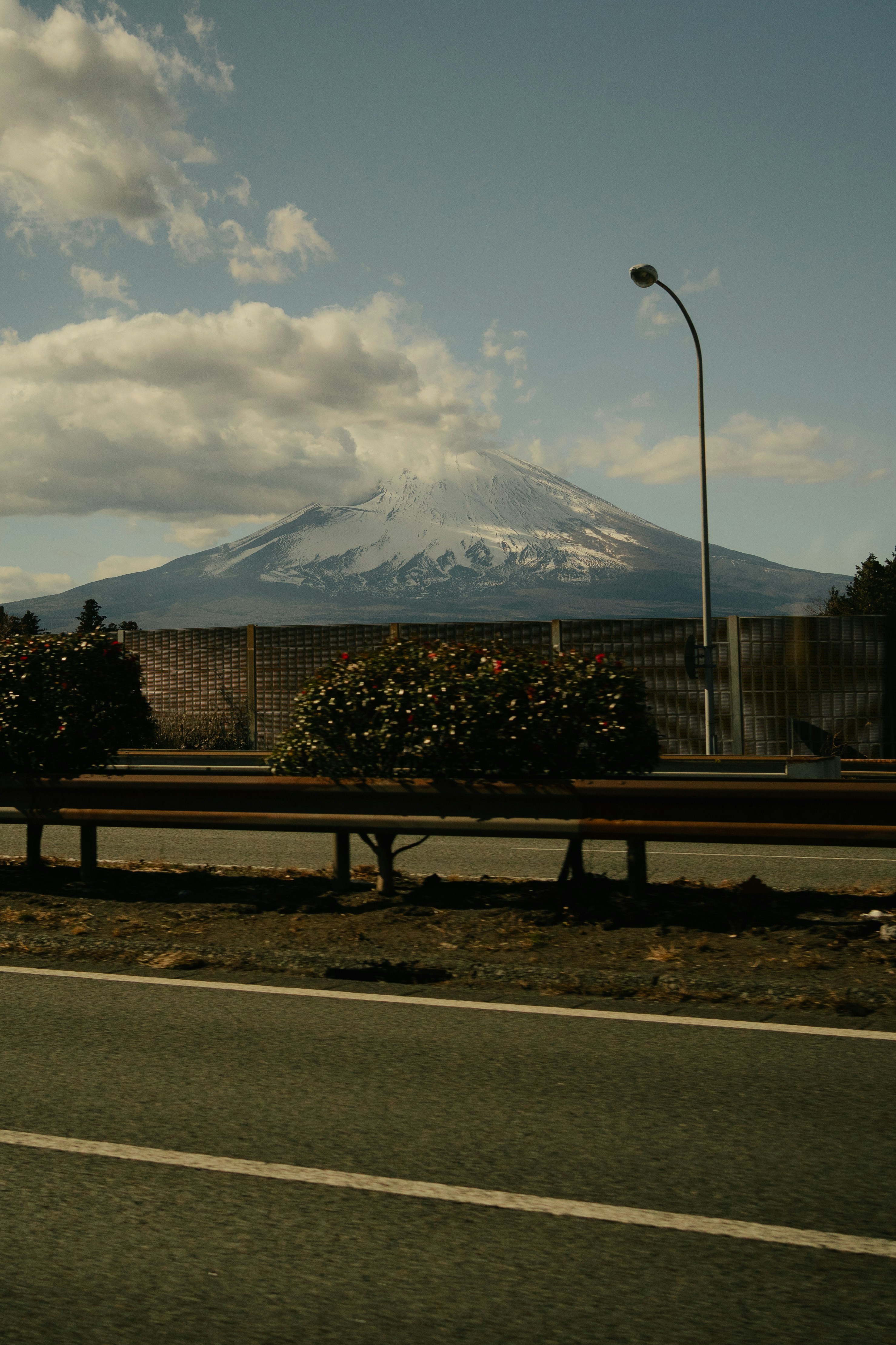 Snow Peak Framed by a Quiet Highway Verge