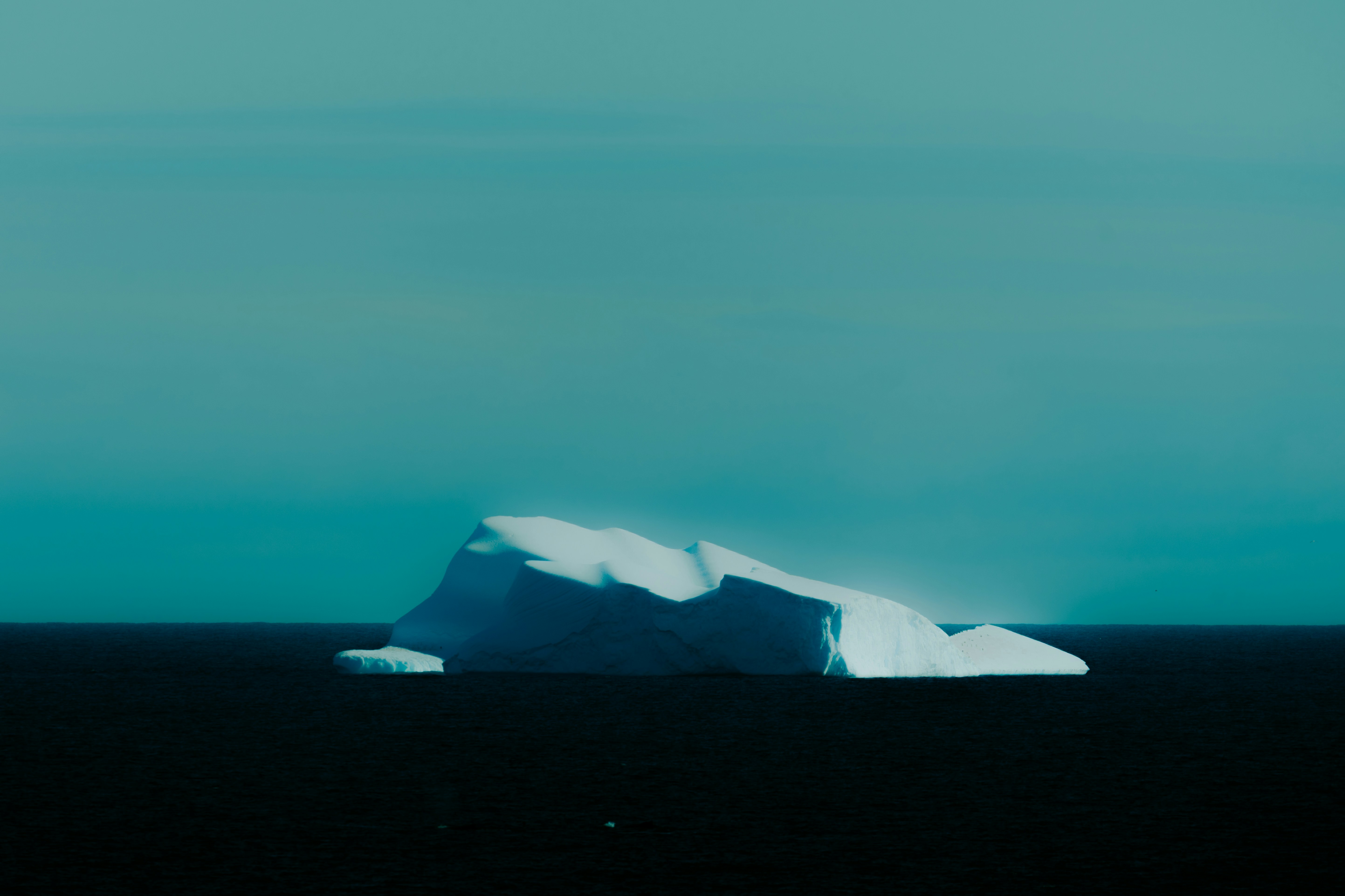 Blue Hour Sentinel: The Quiet Iceberg Beneath a Cyan Horizon