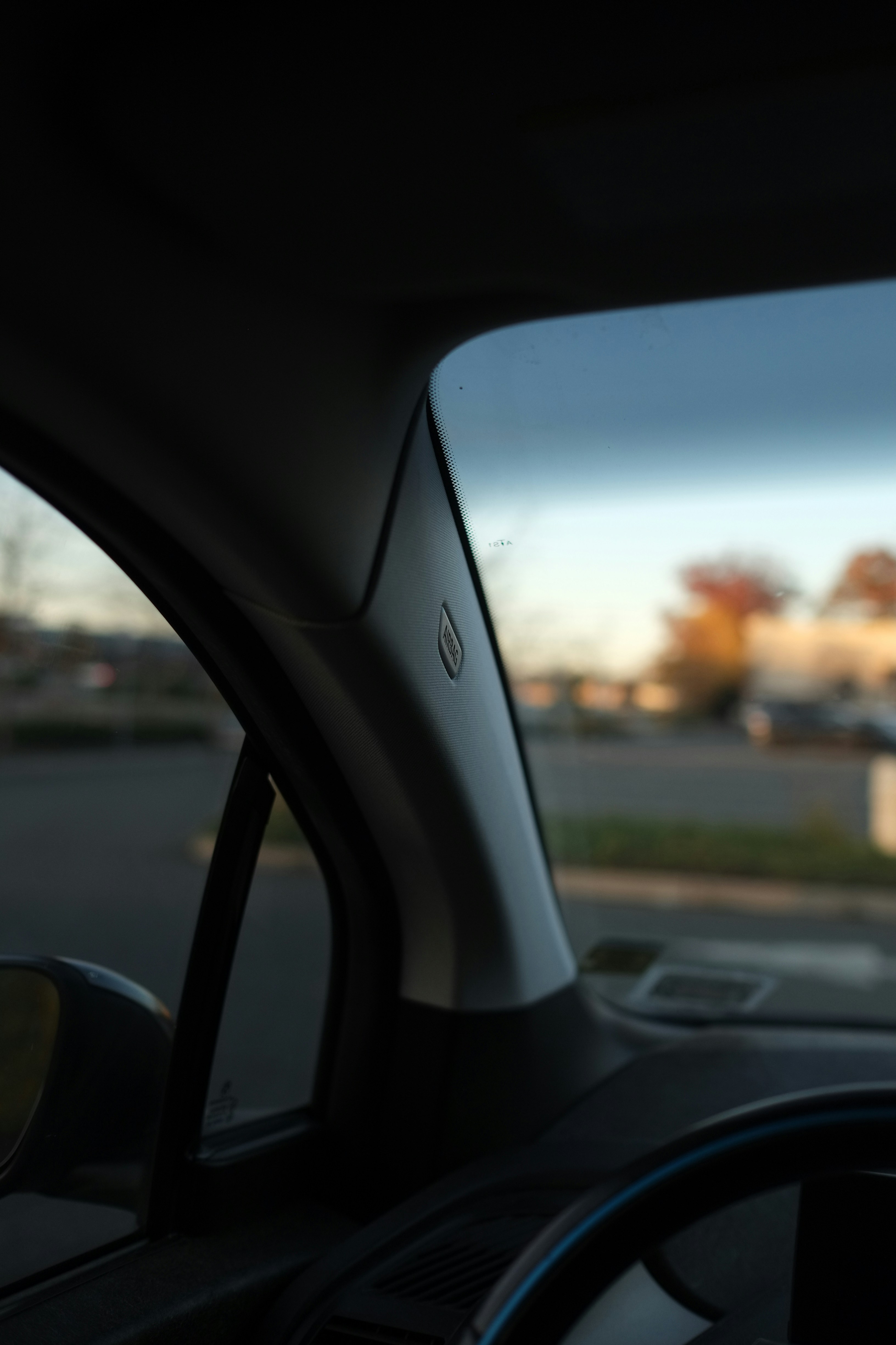 Emblem in Twilight: A-Pillar Glow Through Car Windows