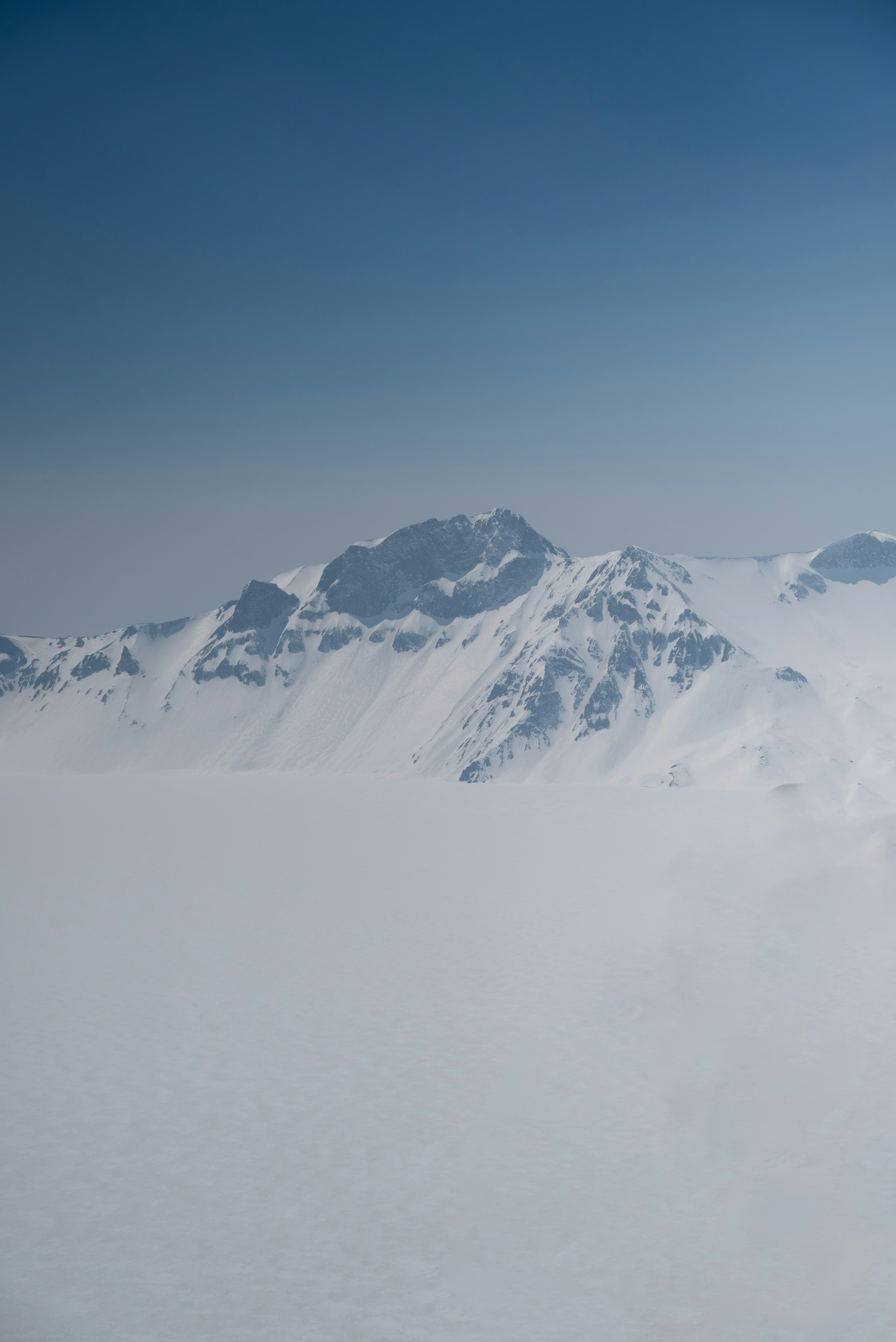 Snowy mountain tops rise above the cloud cover. photo – Free Winter ...