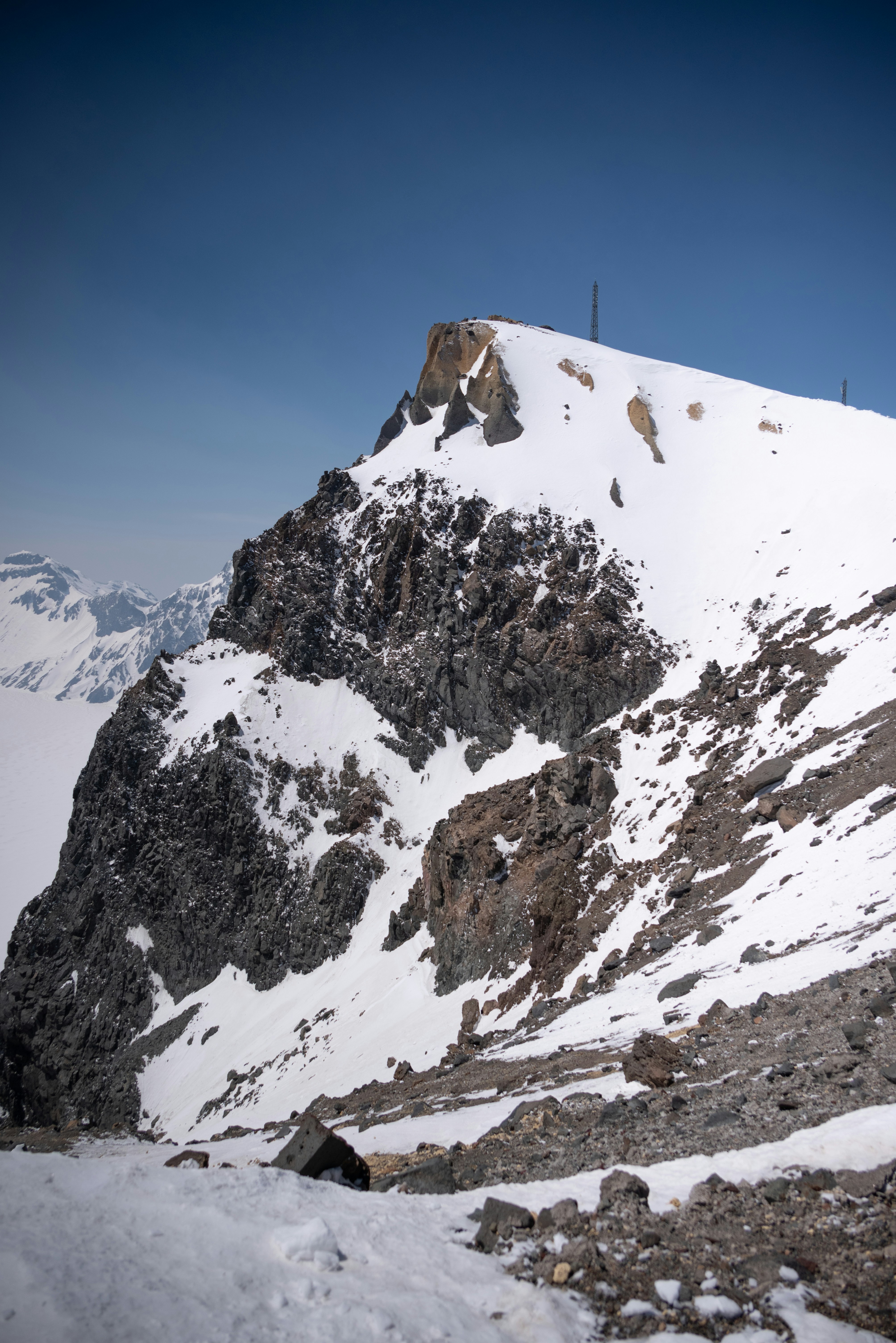 Razor Spine Above the Snowfield: An Alpine Summit Under Cerulean Sky