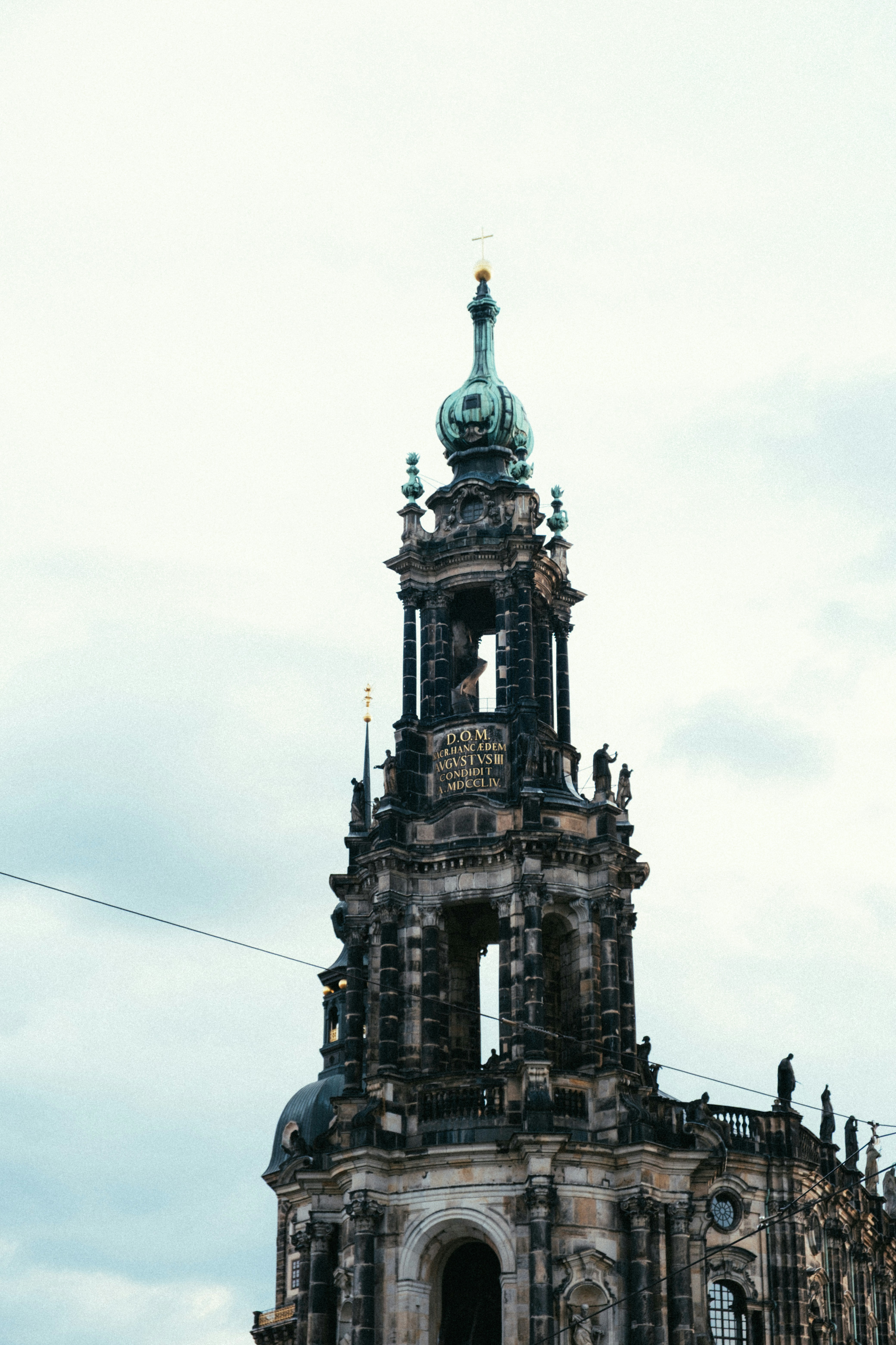 Turquoise-Domed Baroque Spire Reaching the Pale Sky