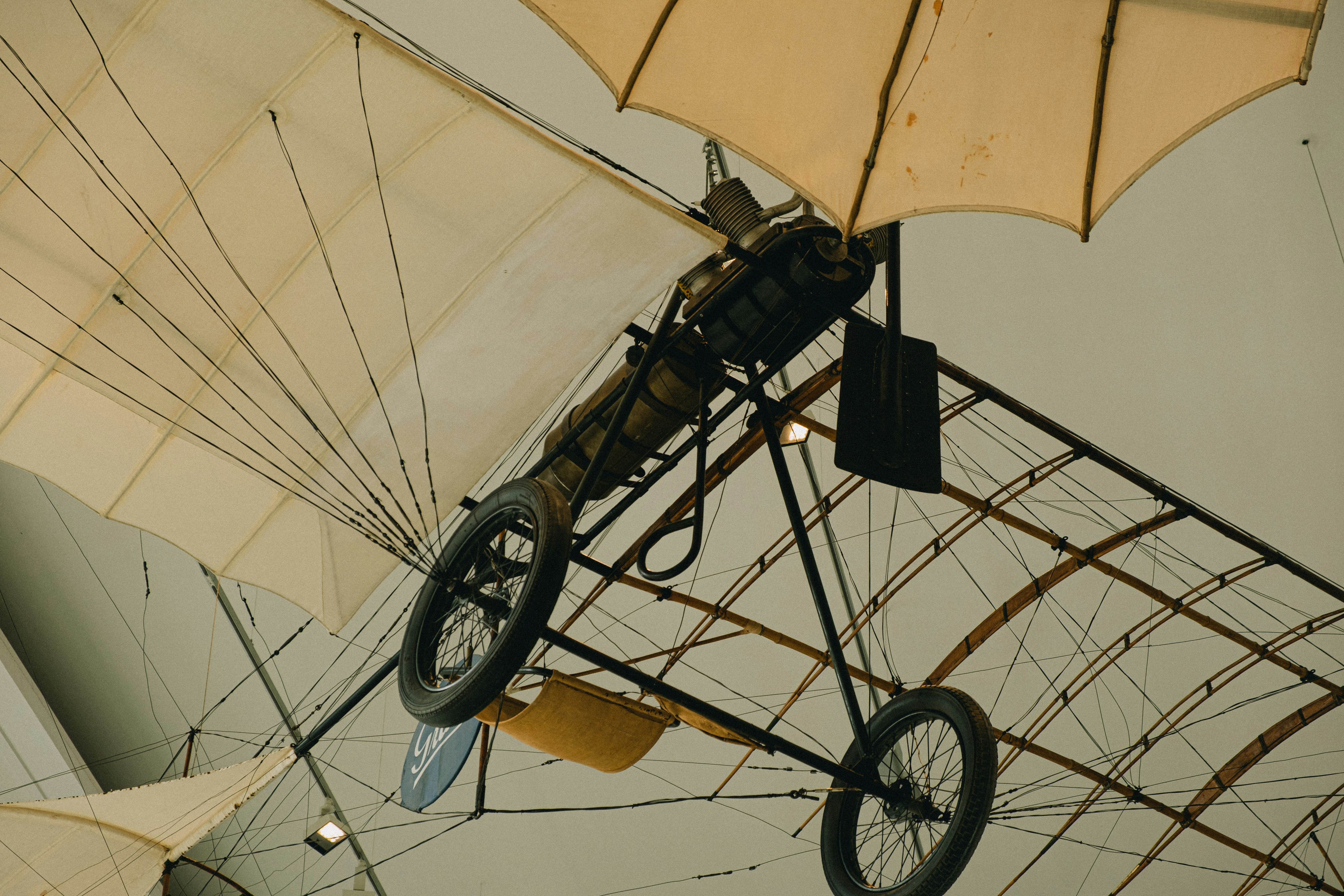 Ceiling Heritage: A Vintage Biplane Hoisted in an Industrial Gallery