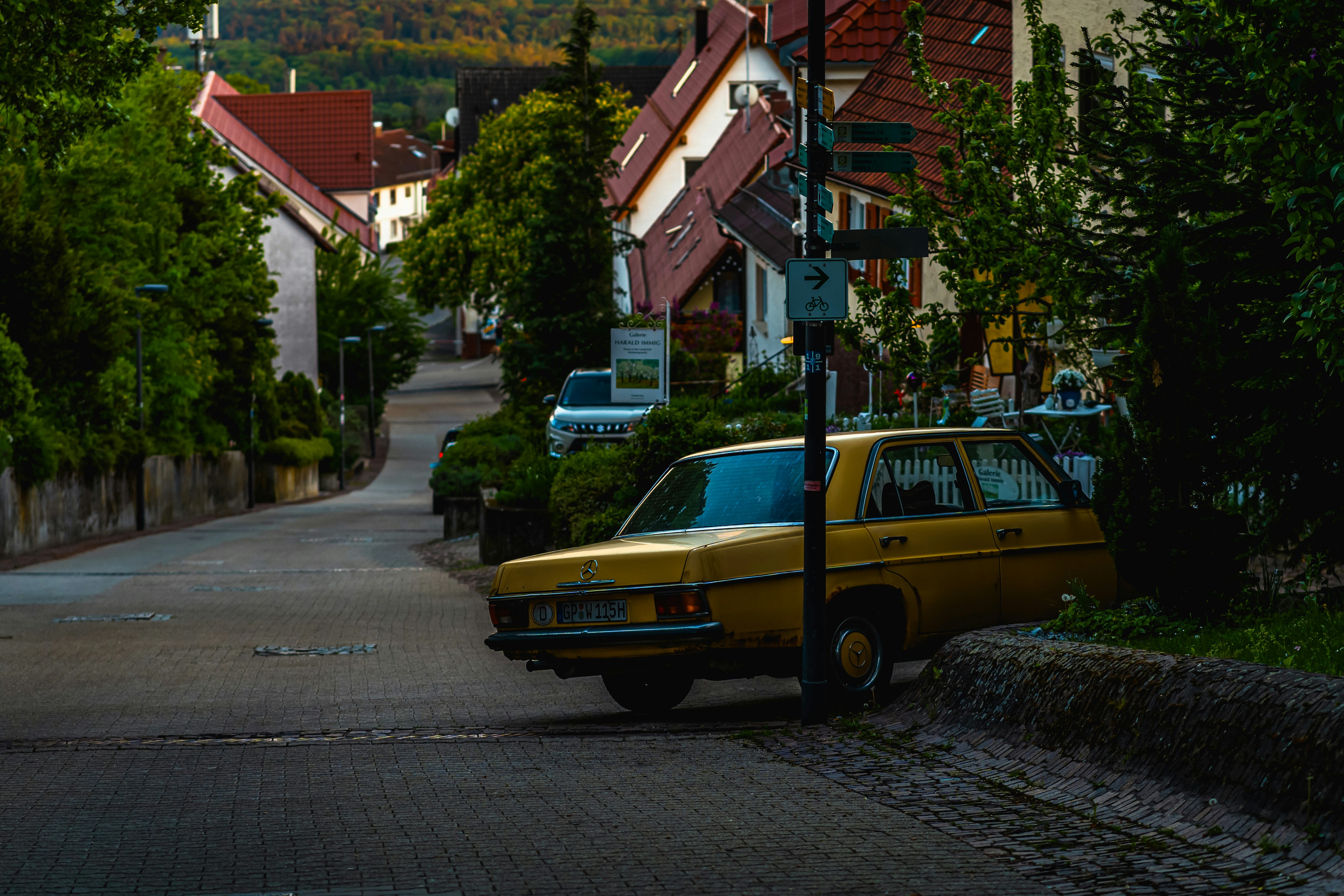 Yellow Classic on a Quiet Cobblestone Street