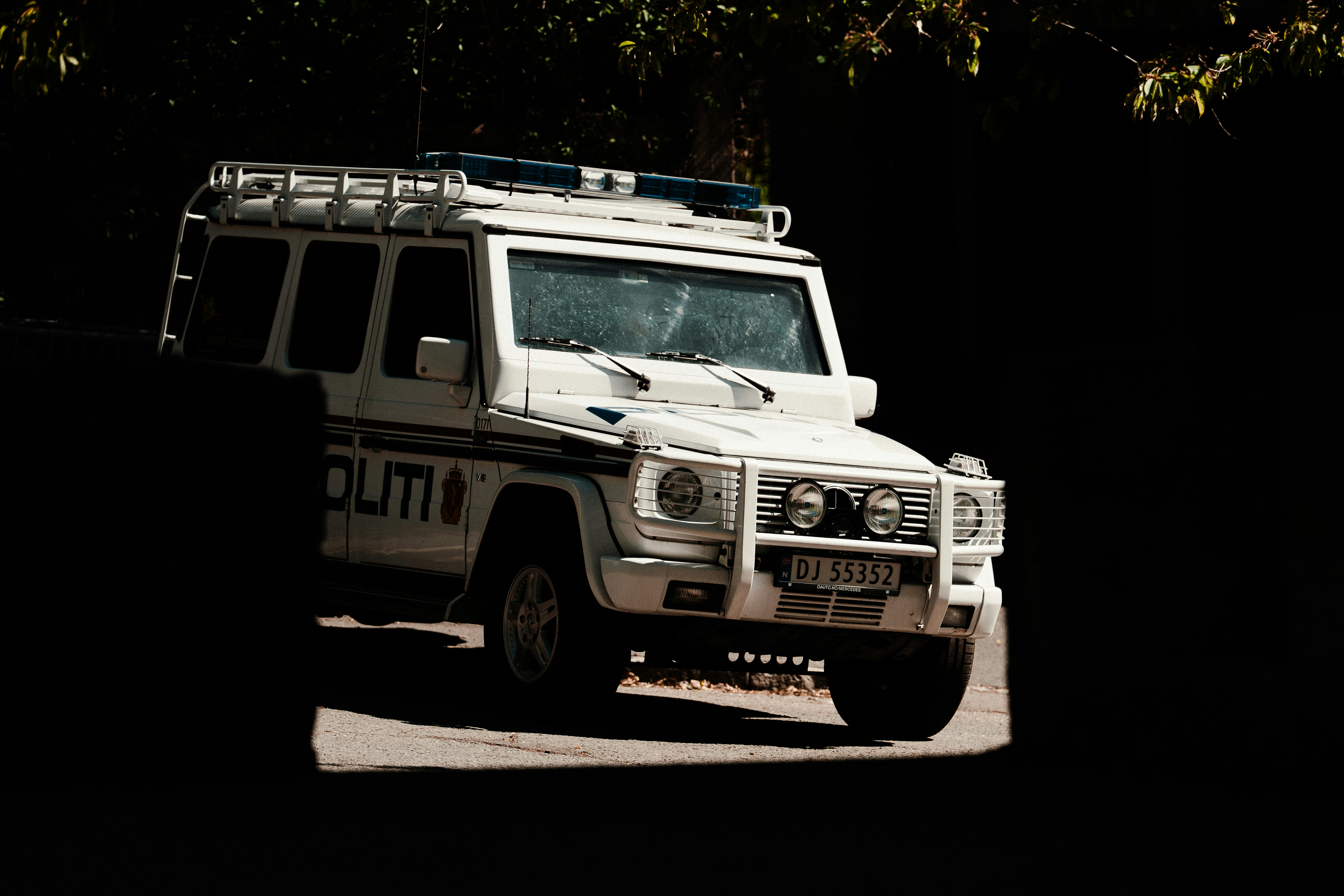 A white police suv is parked in the shadows. photo – Free Car Image on ...
