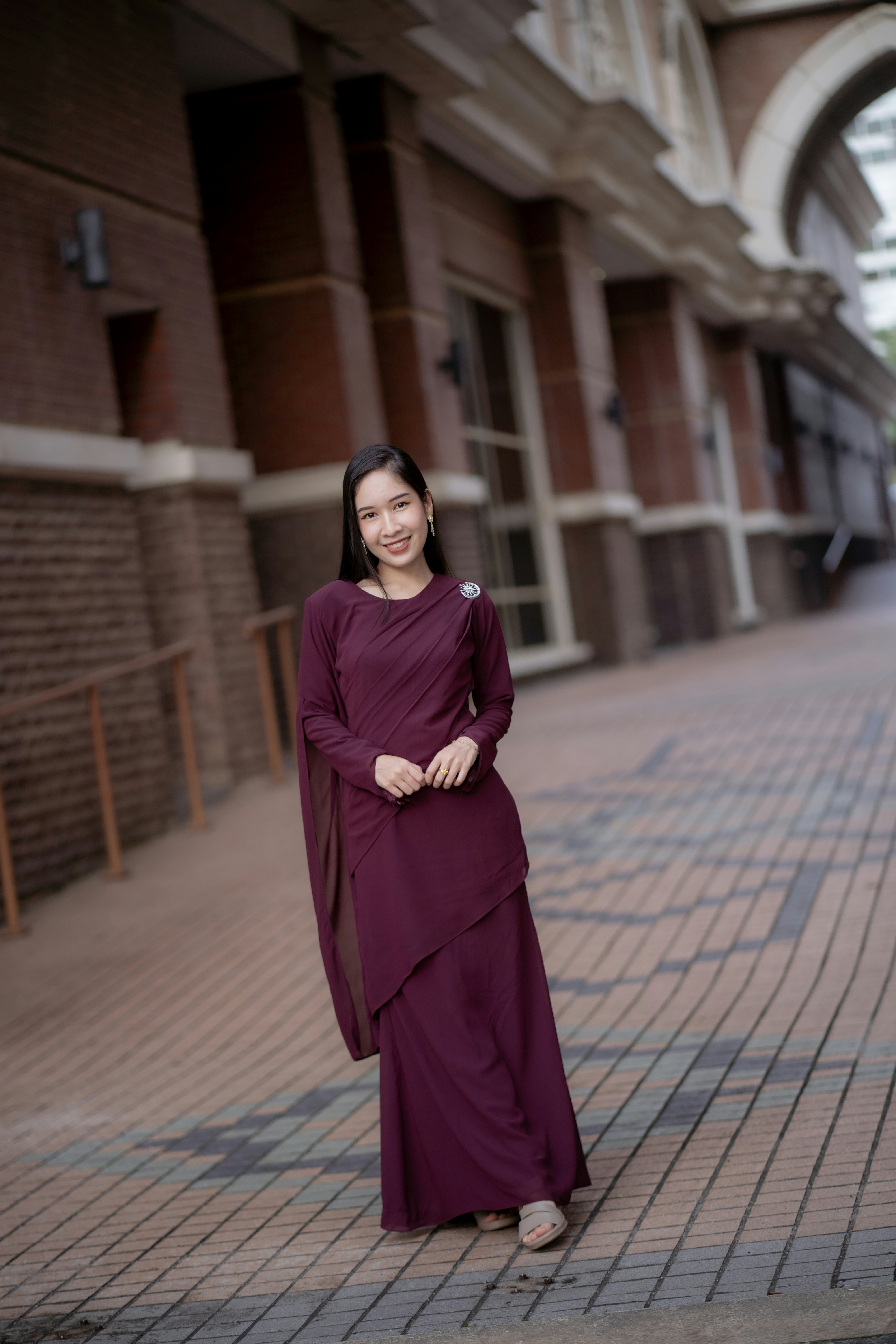 Burgundy Gown in the Arcaded Urban Corridor