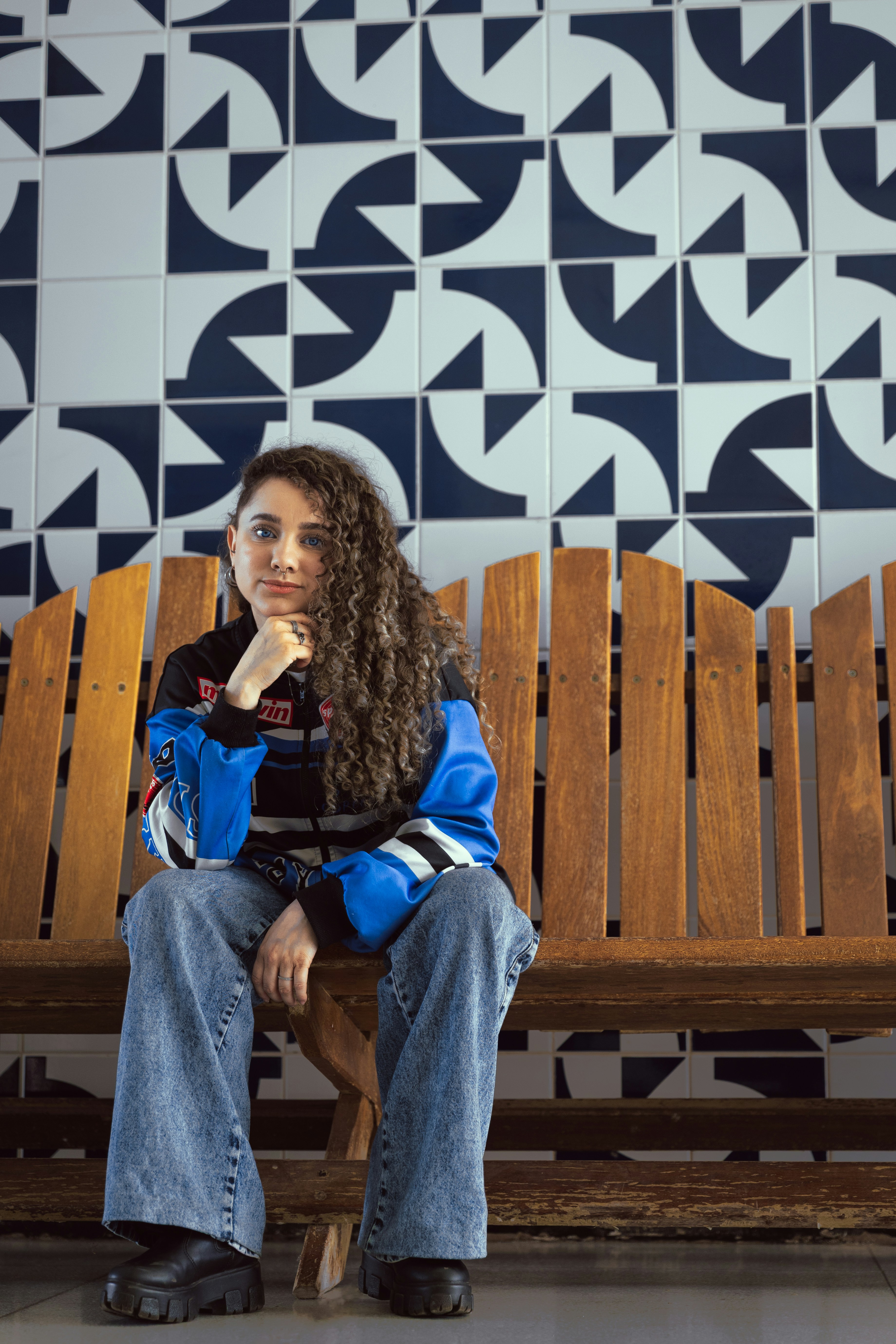 Blue Between Tiles: A Quiet Portrait on a Wooden Bench