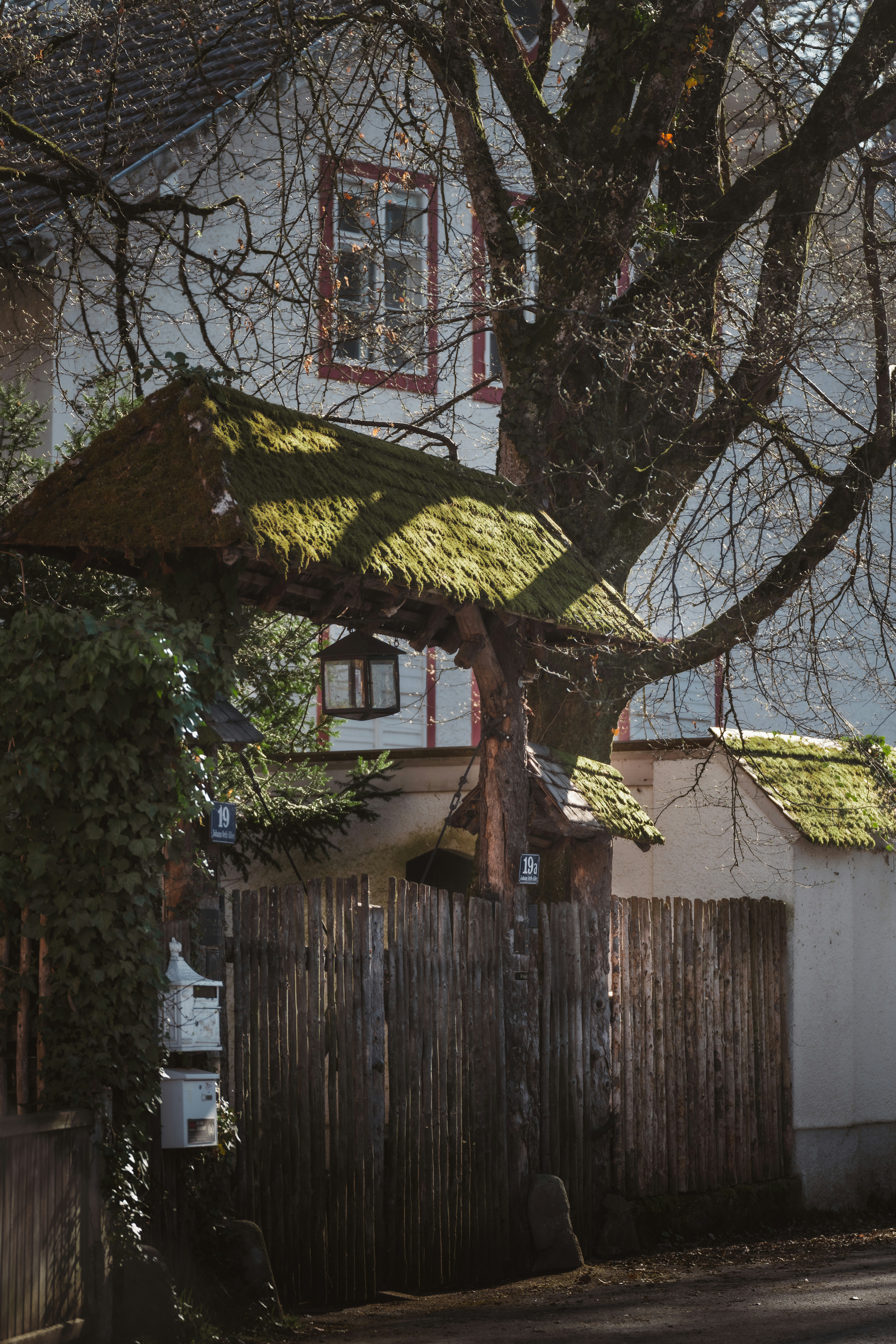 Moss-Topped Gateframe Guarding a Quiet Courtyard