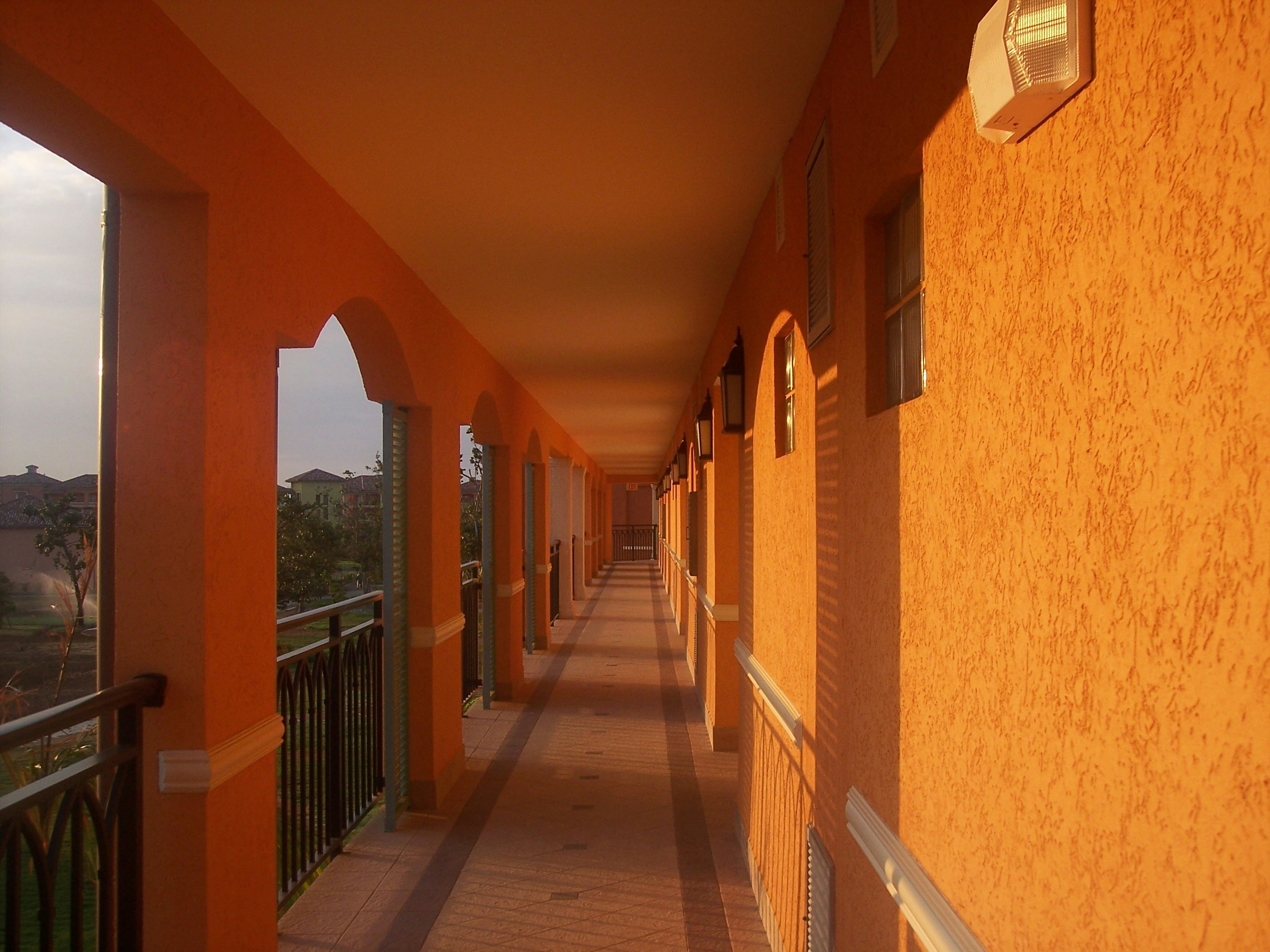 Orange corridor with arched columns and railing. photo – Free Image on ...