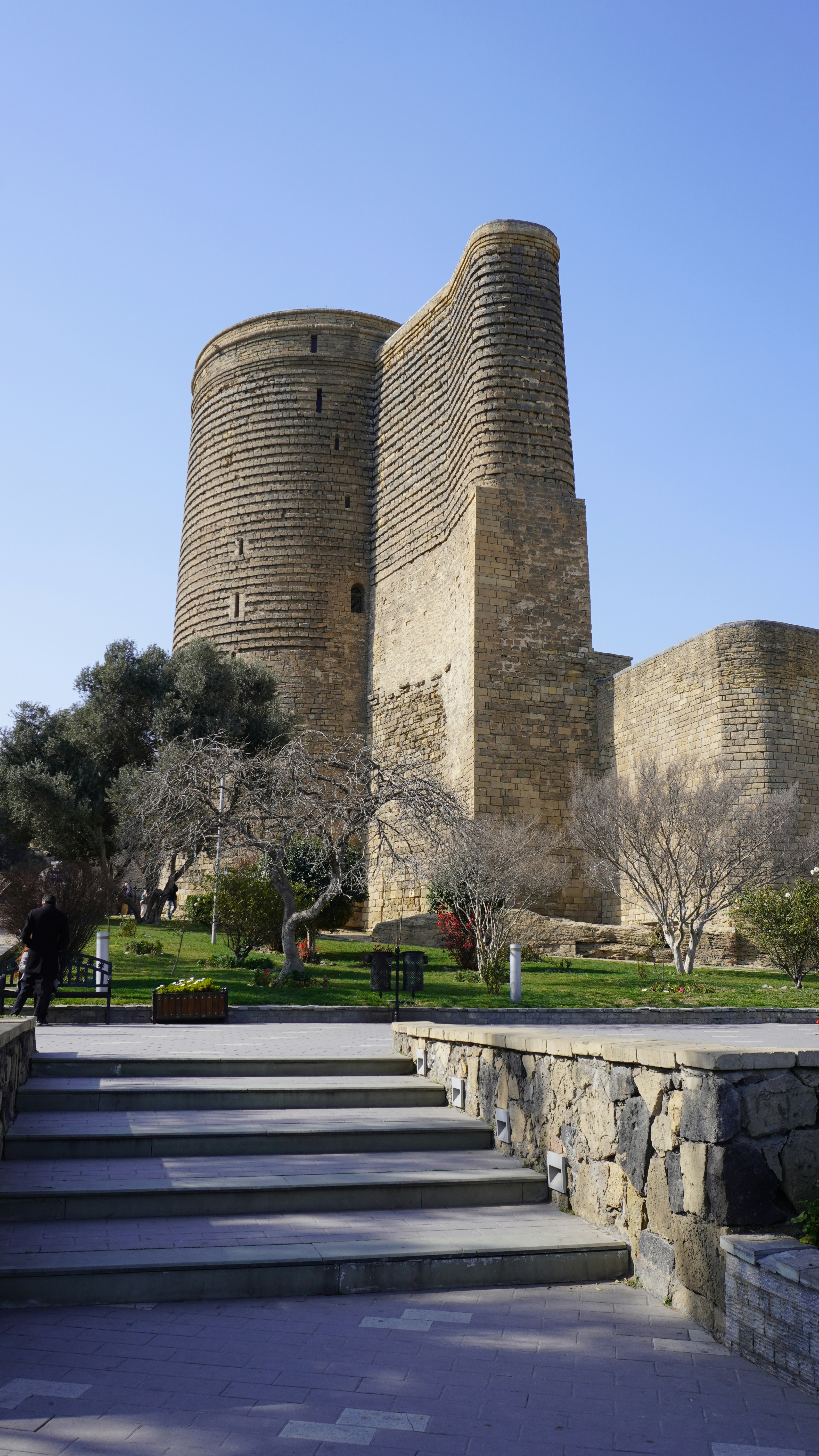 Stone Sentinel: Cylindrical Towers Guard a Tranquil Terrace