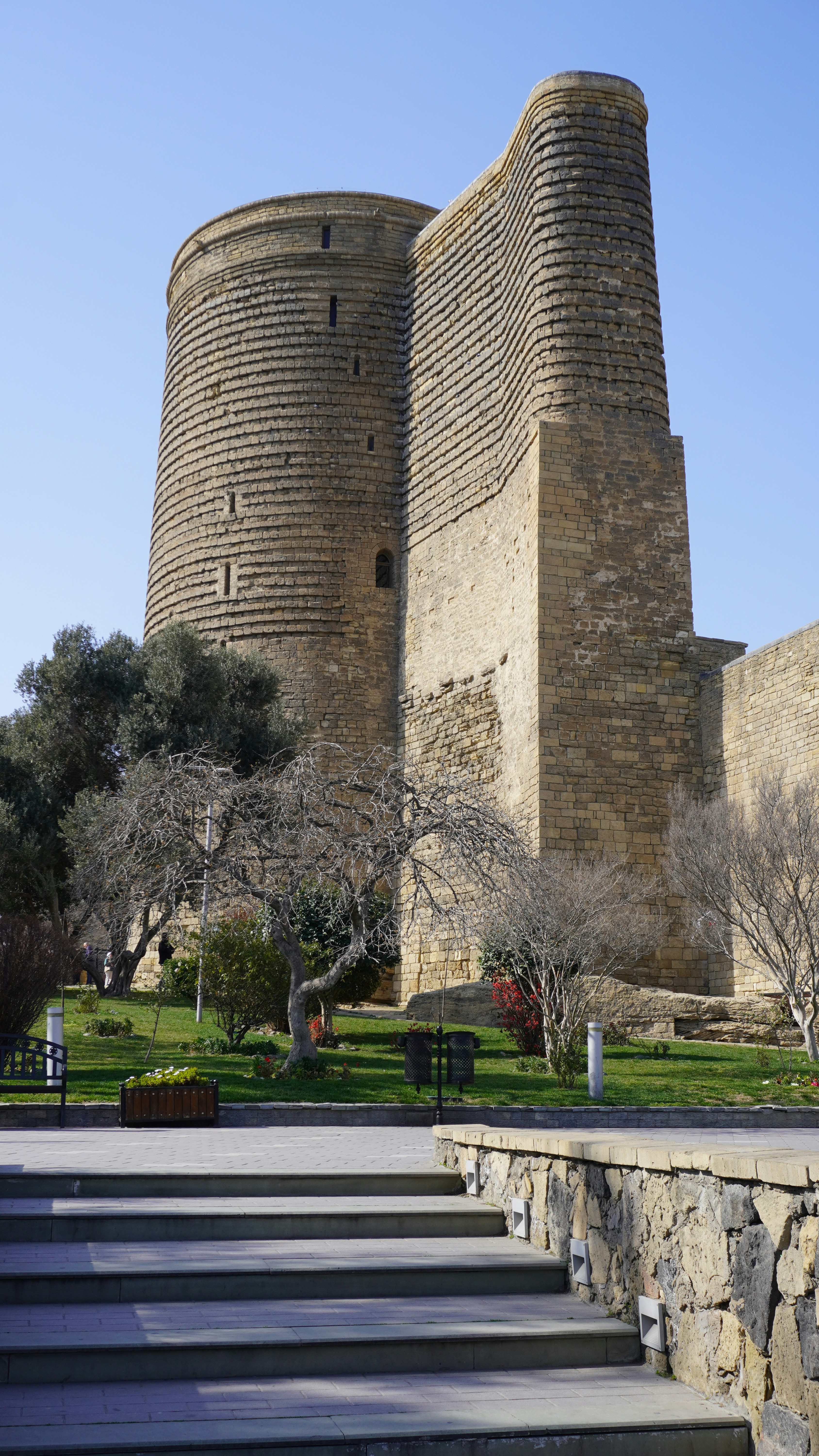 A stone tower stands tall against a bright blue sky. photo – Free ...